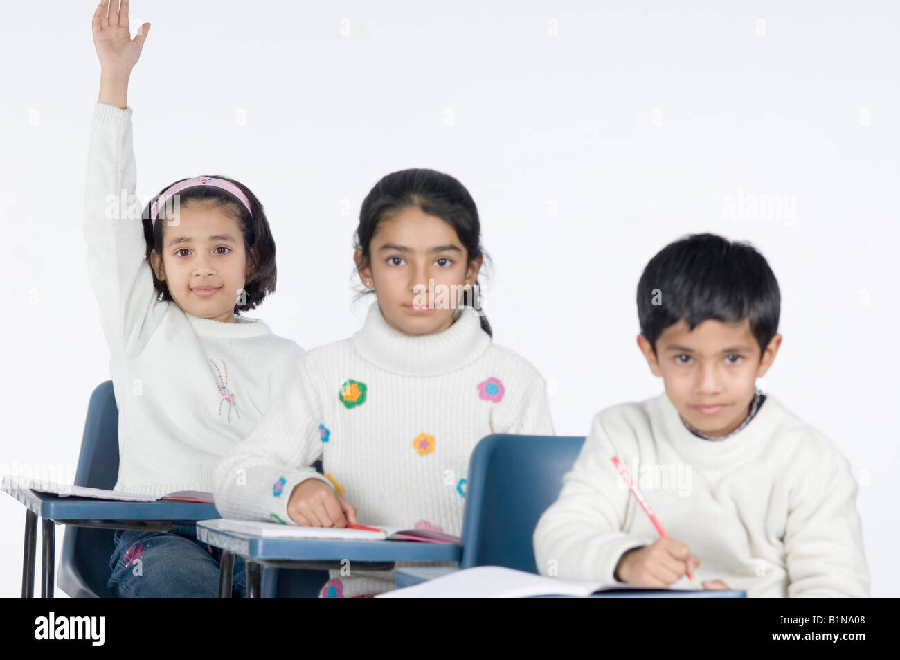 Three students sitting in a classroom Stock Photo - Alamy