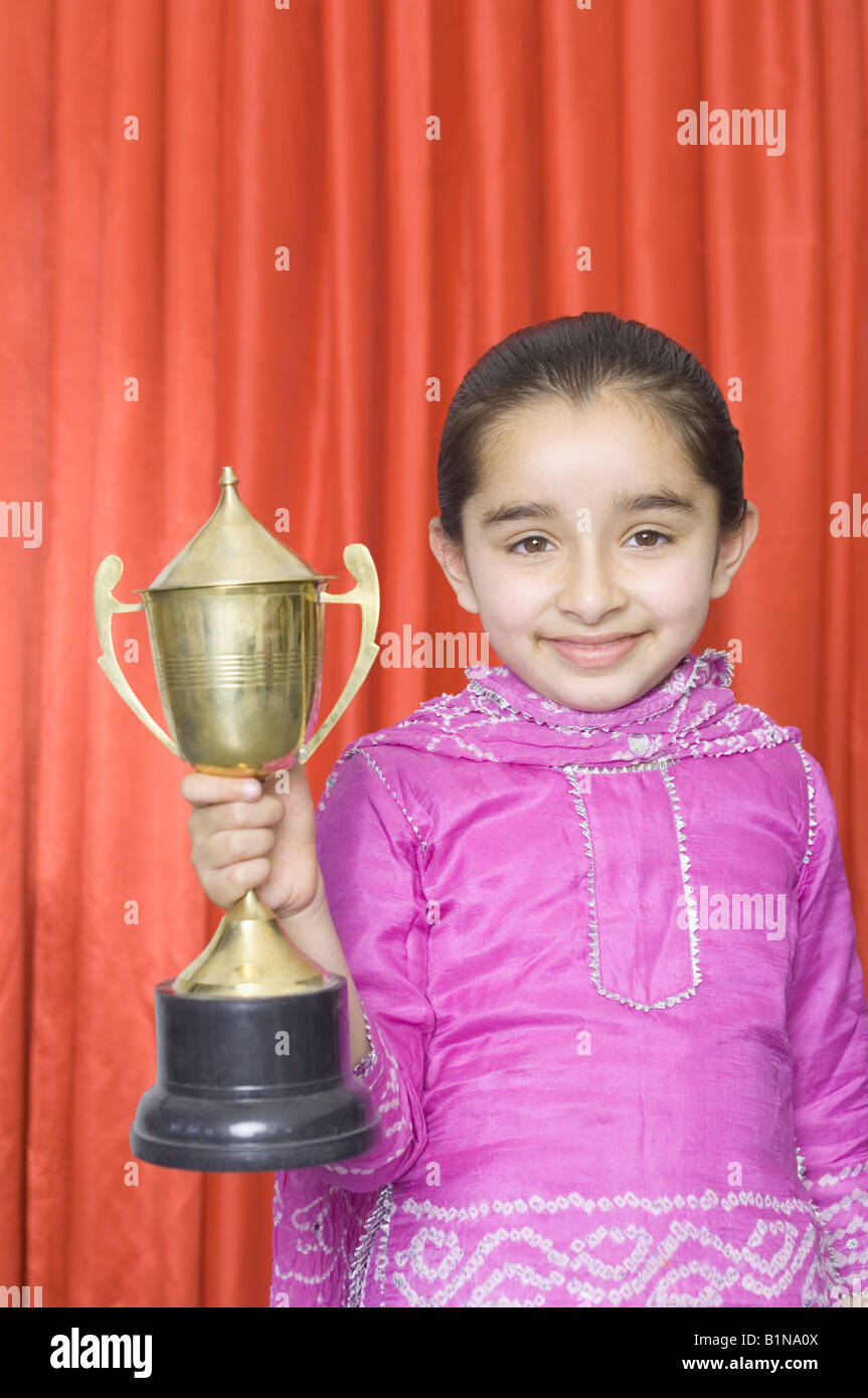 Close-up of a girl holding a trophy Stock Photo - Alamy