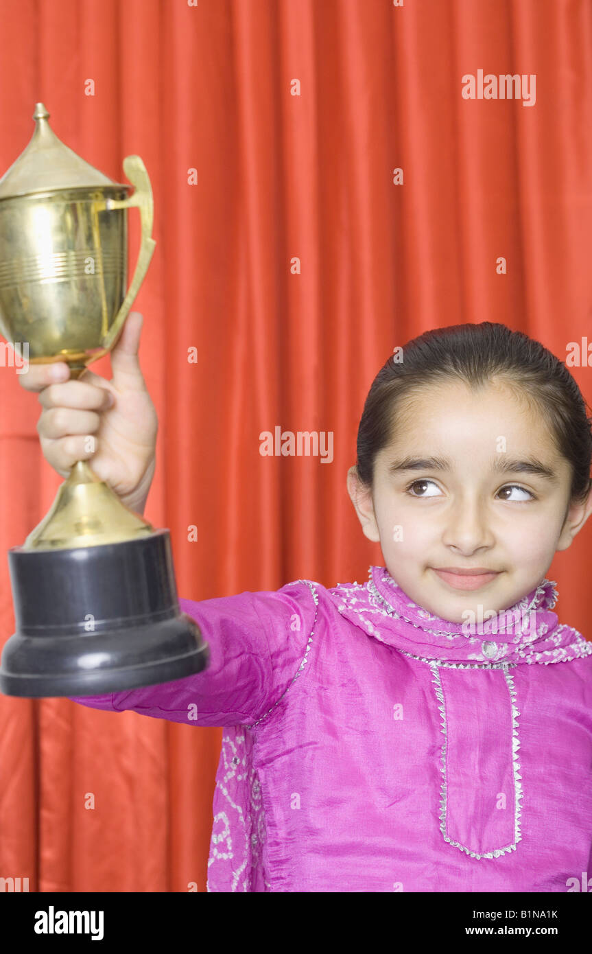 Close-up of a girl holding a trophy Stock Photo - Alamy