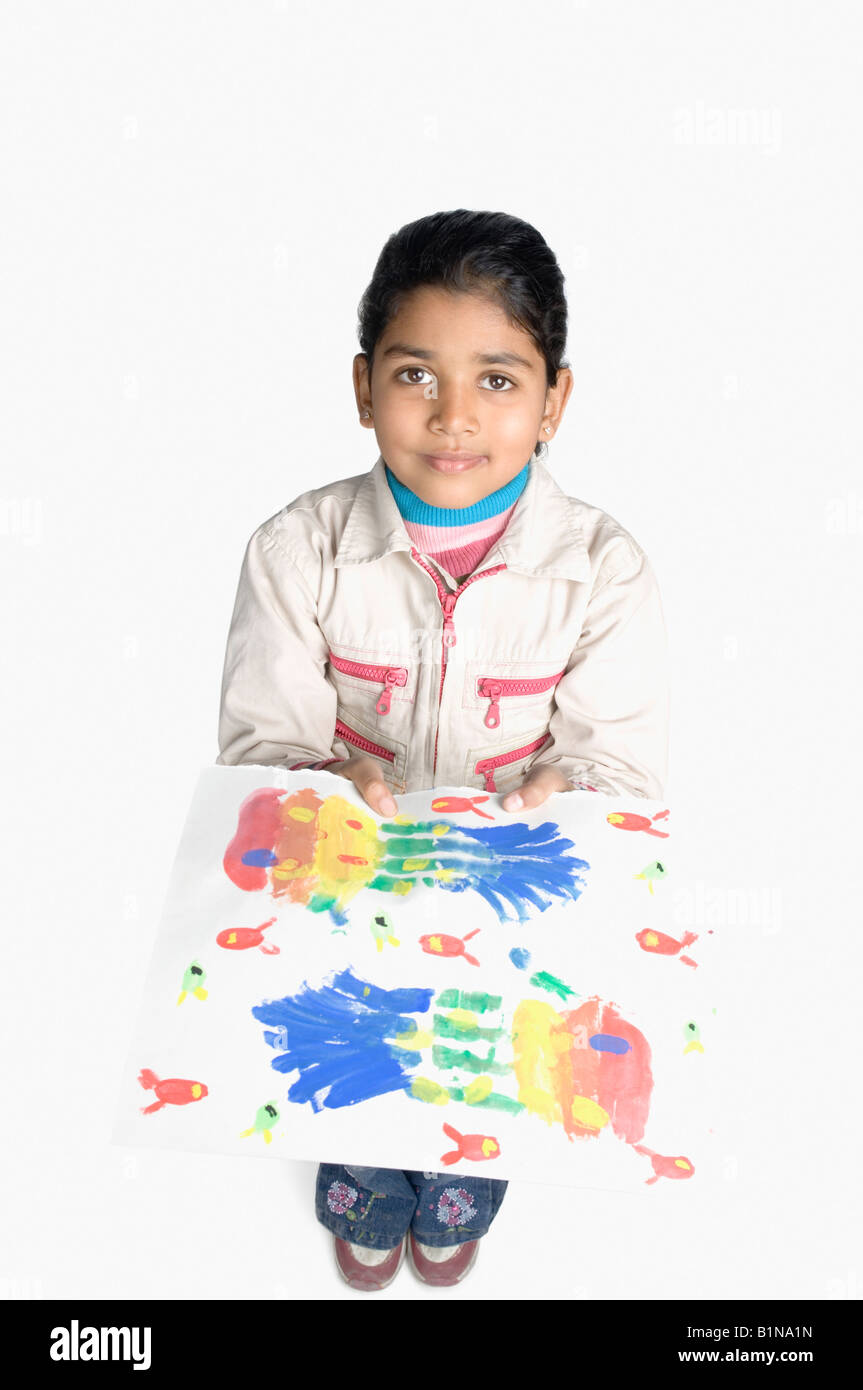 High angle view of a girl showing a drawing Stock Photo - Alamy