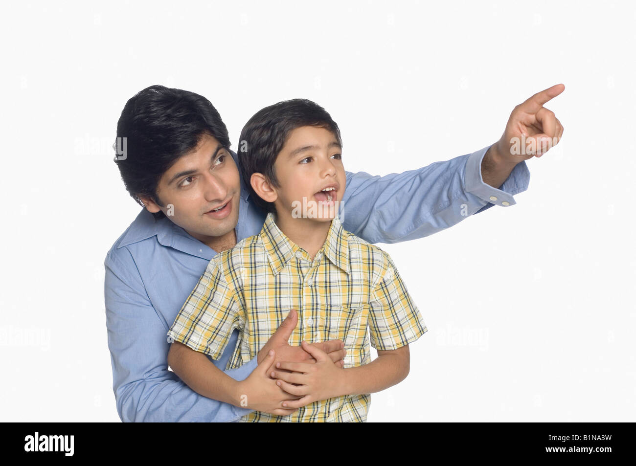 Close-up of a young man pointing and his son looking away Stock Photo ...