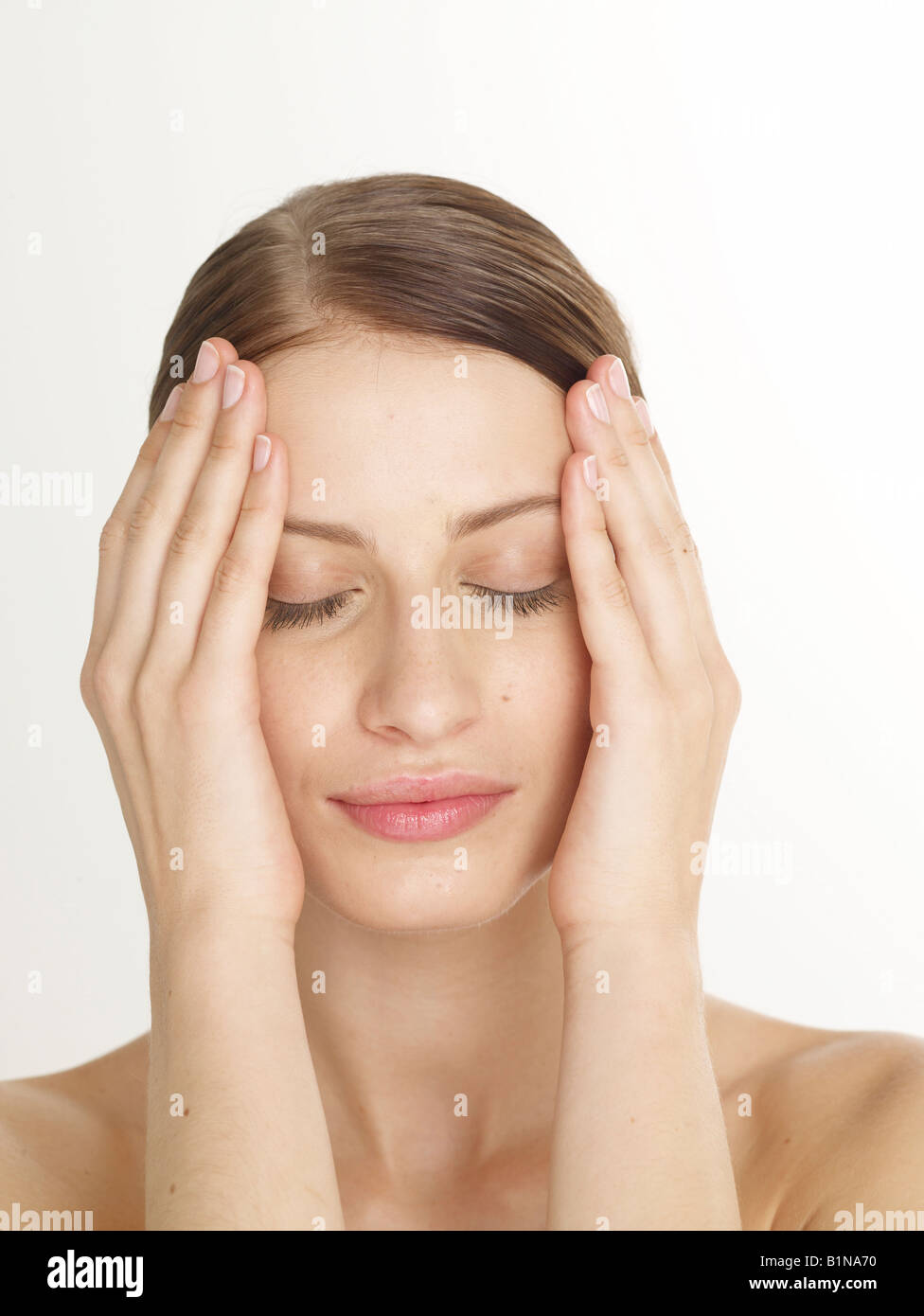 Woman is putting hands on her face Stock Photo - Alamy