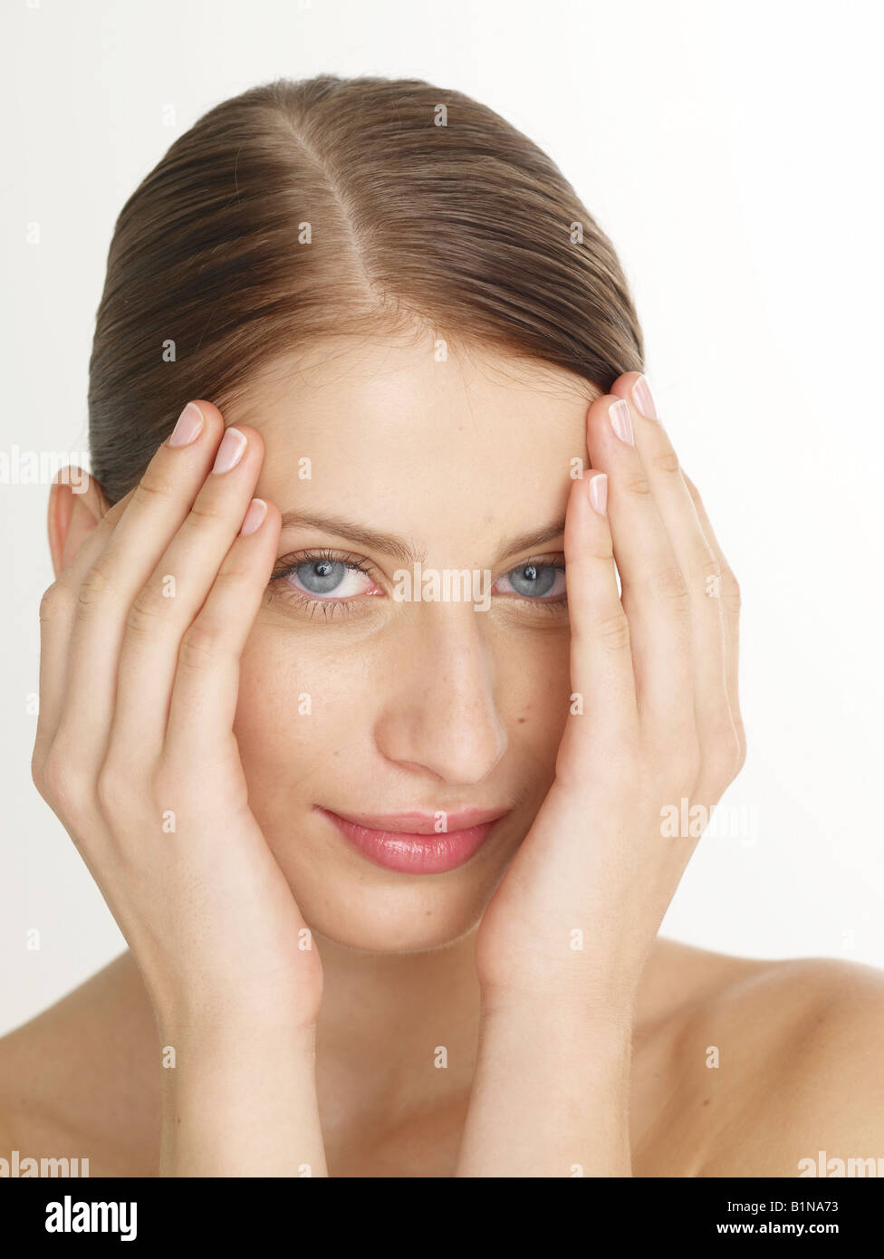 Woman is putting hands on her face Stock Photo - Alamy