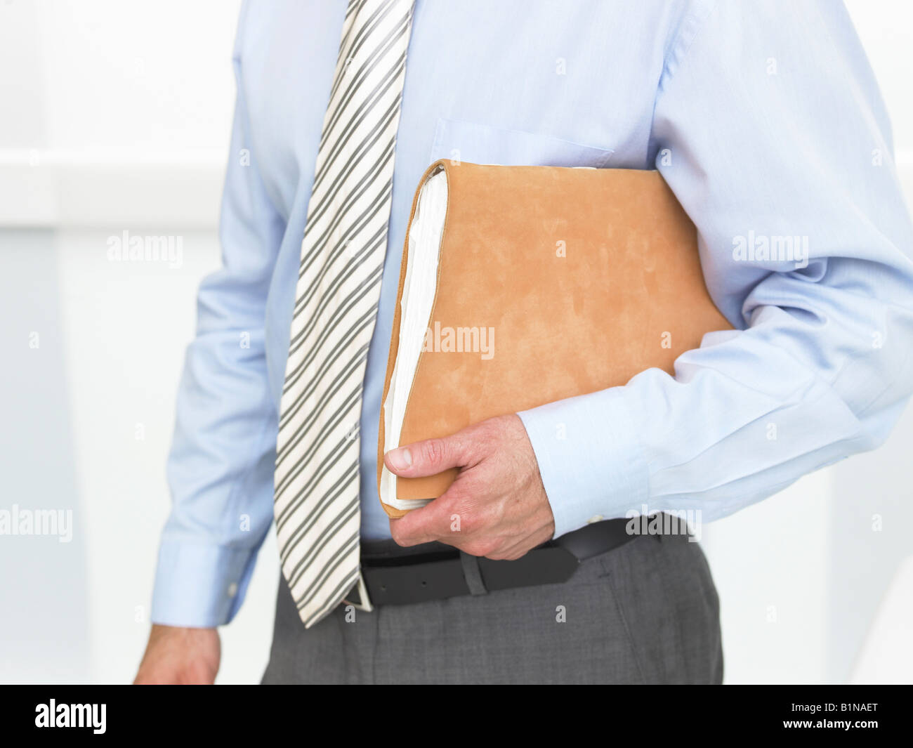 File under a business man arm Stock Photo - Alamy