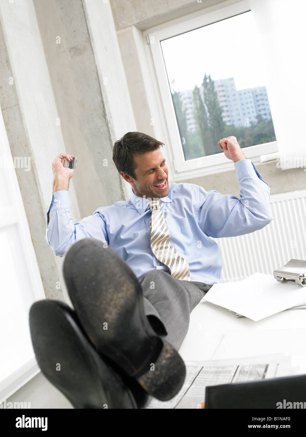 Jubilating business man Stock Photo - Alamy
