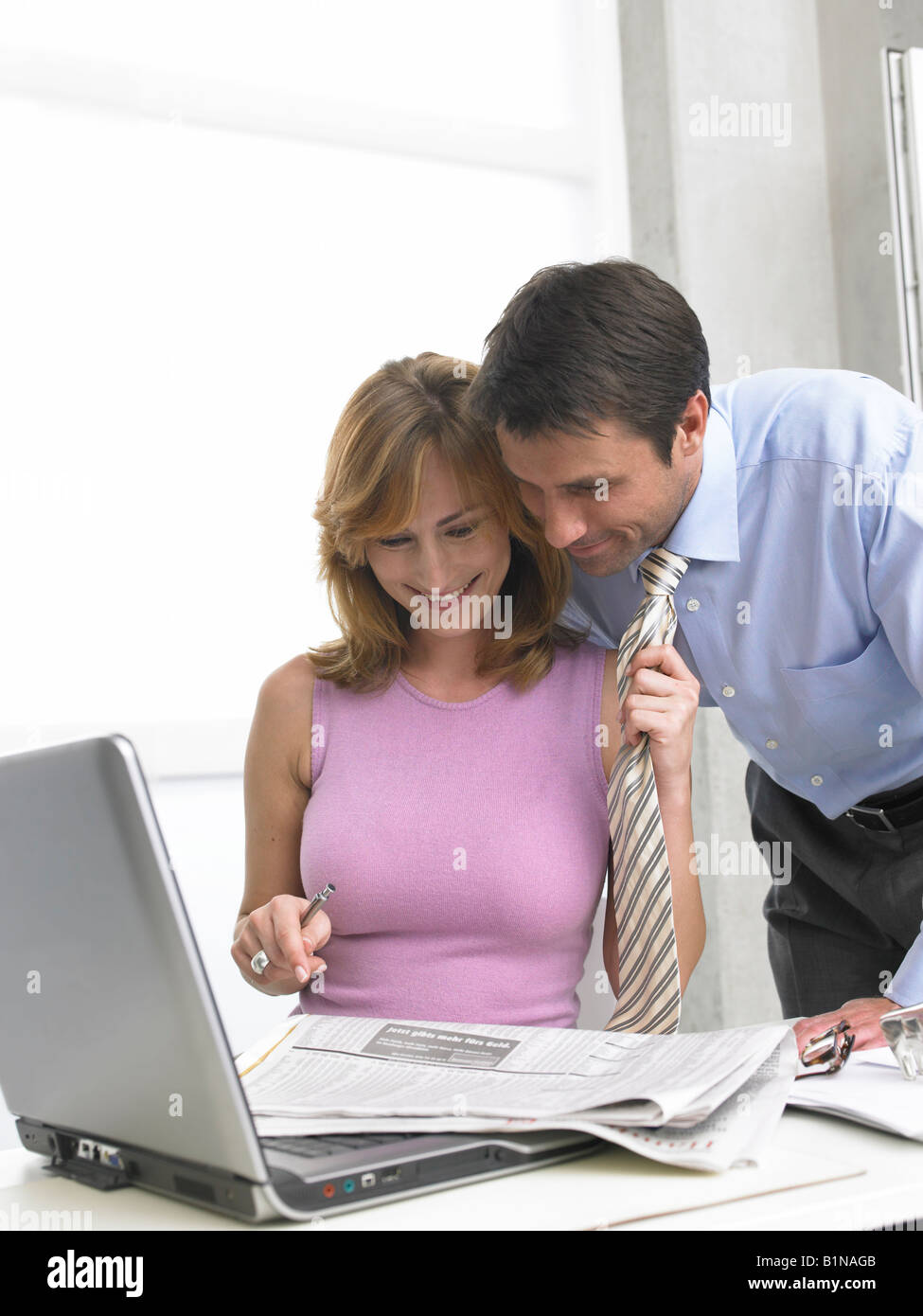 Woman is pulling his tie Stock Photo - Alamy
