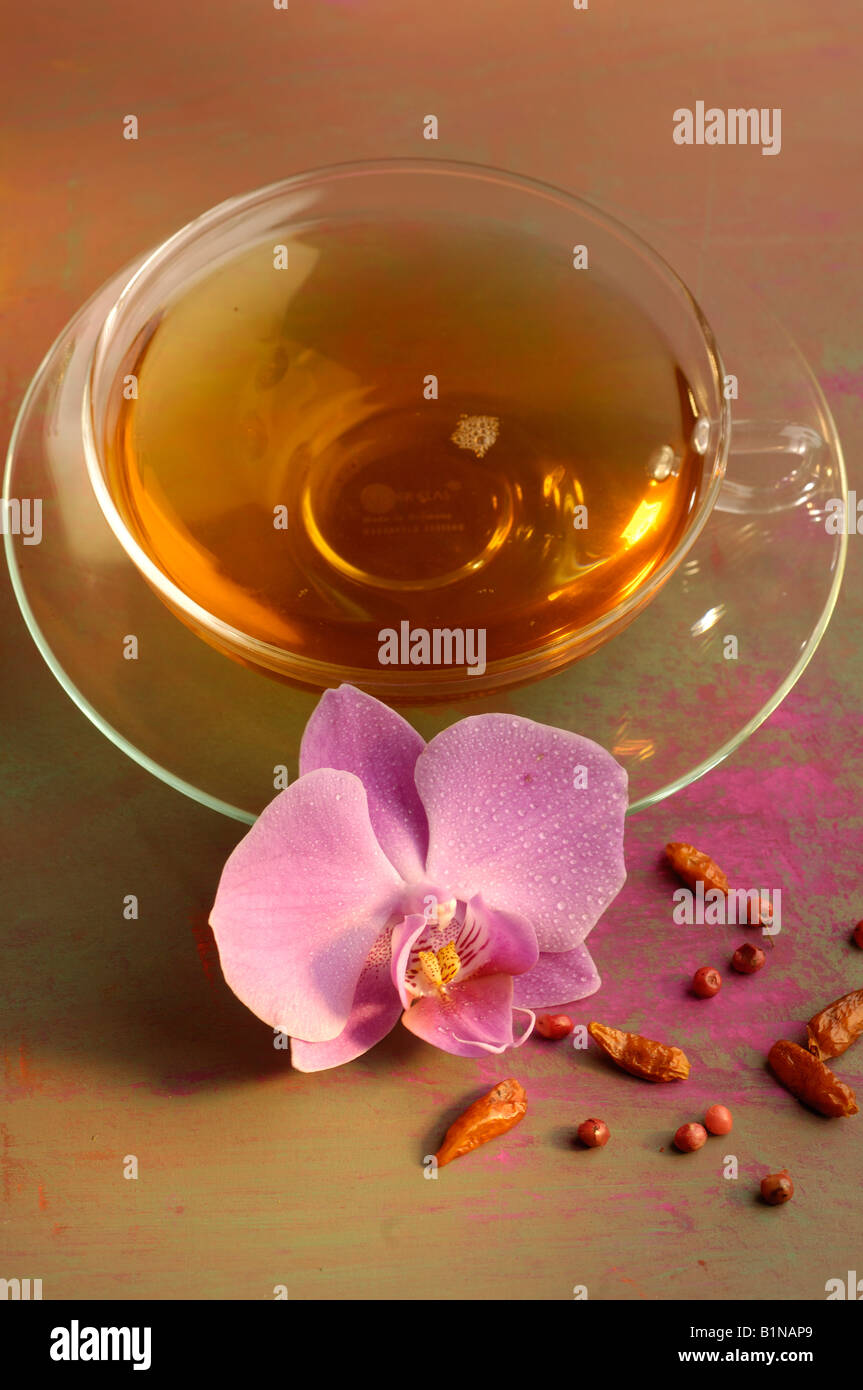 Tea with chili peper and a orchid blossom Stock Photo - Alamy
