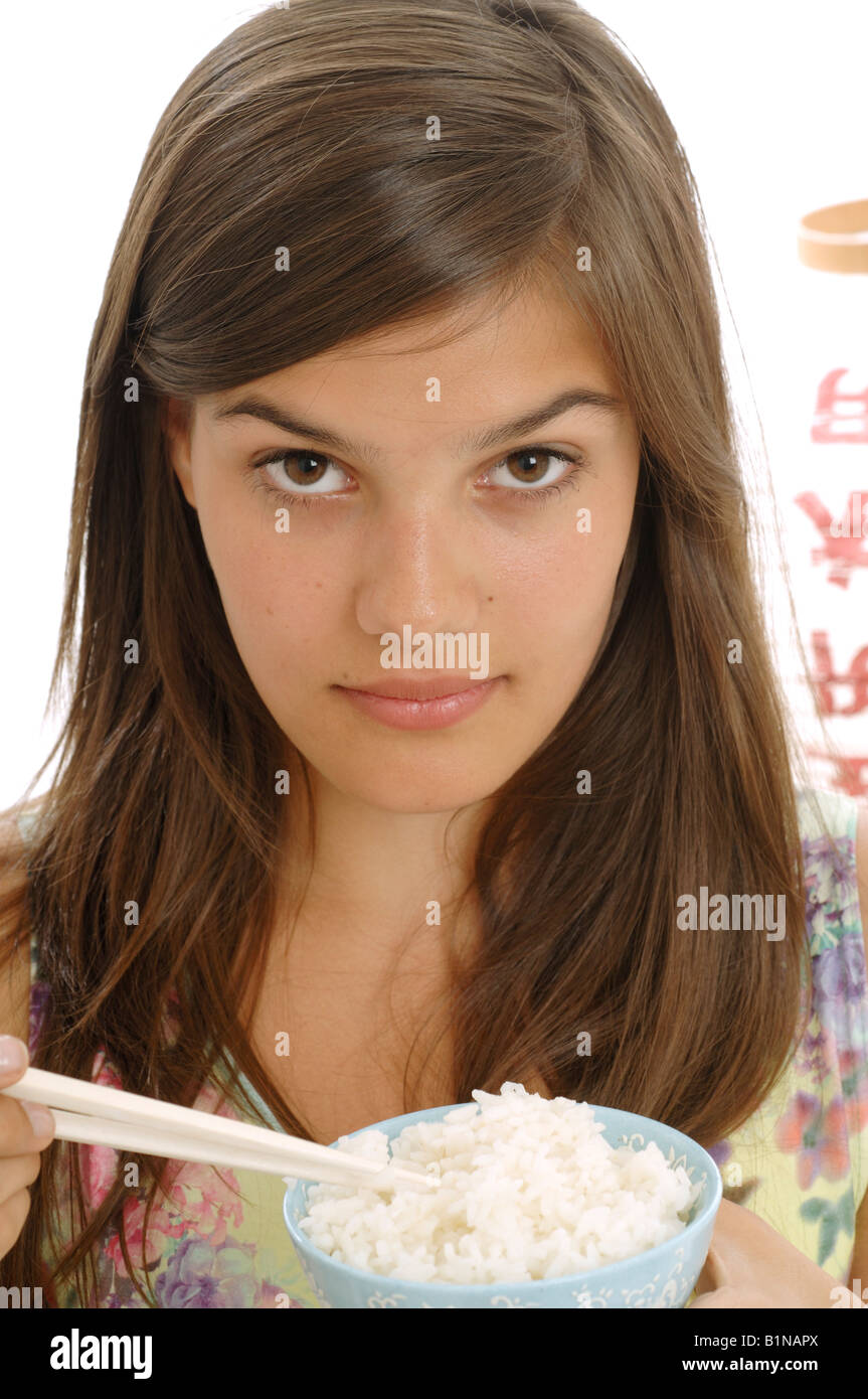 Woman is eating rice with chopsticks Stock Photo - Alamy