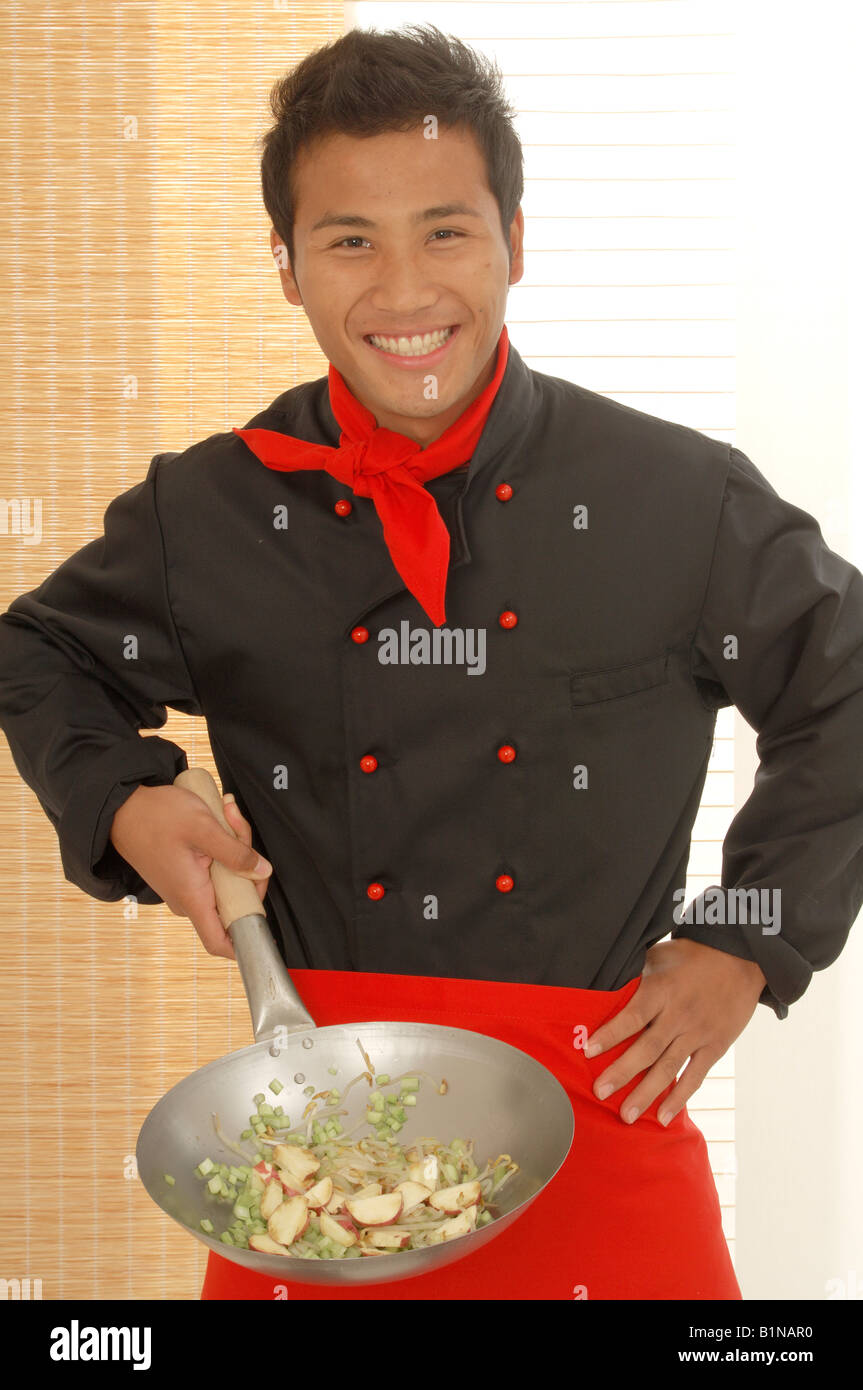 Asian cook with a peking pan Stock Photo - Alamy