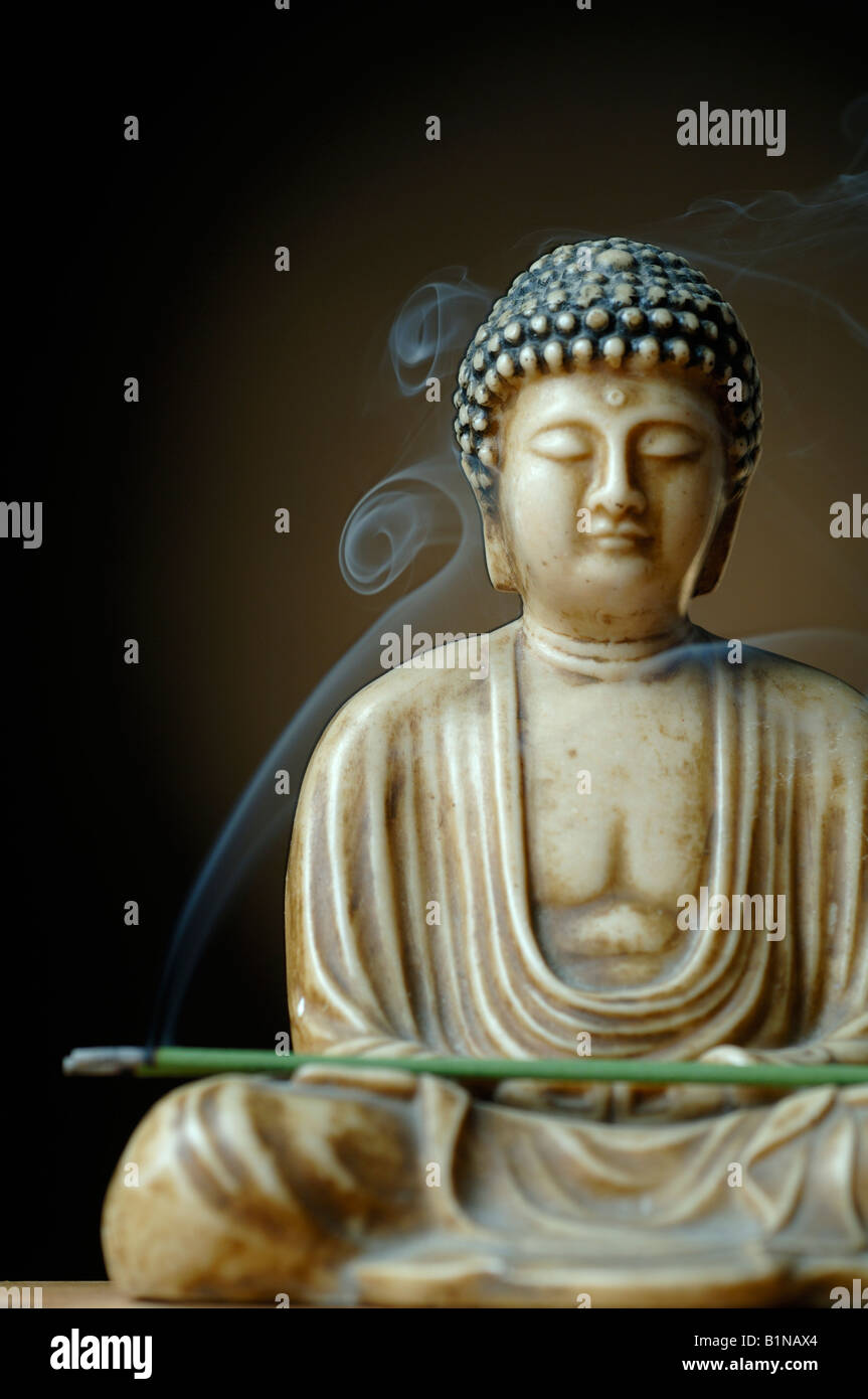 Buddha with a joss stick Stock Photo - Alamy
