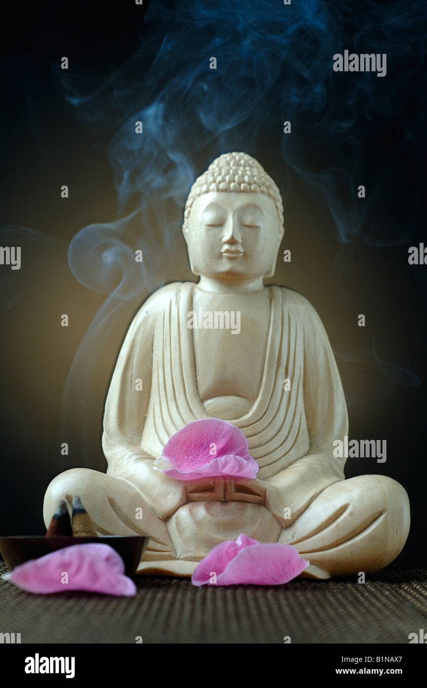 Buddha with joss sticks and pink petals Stock Photo - Alamy