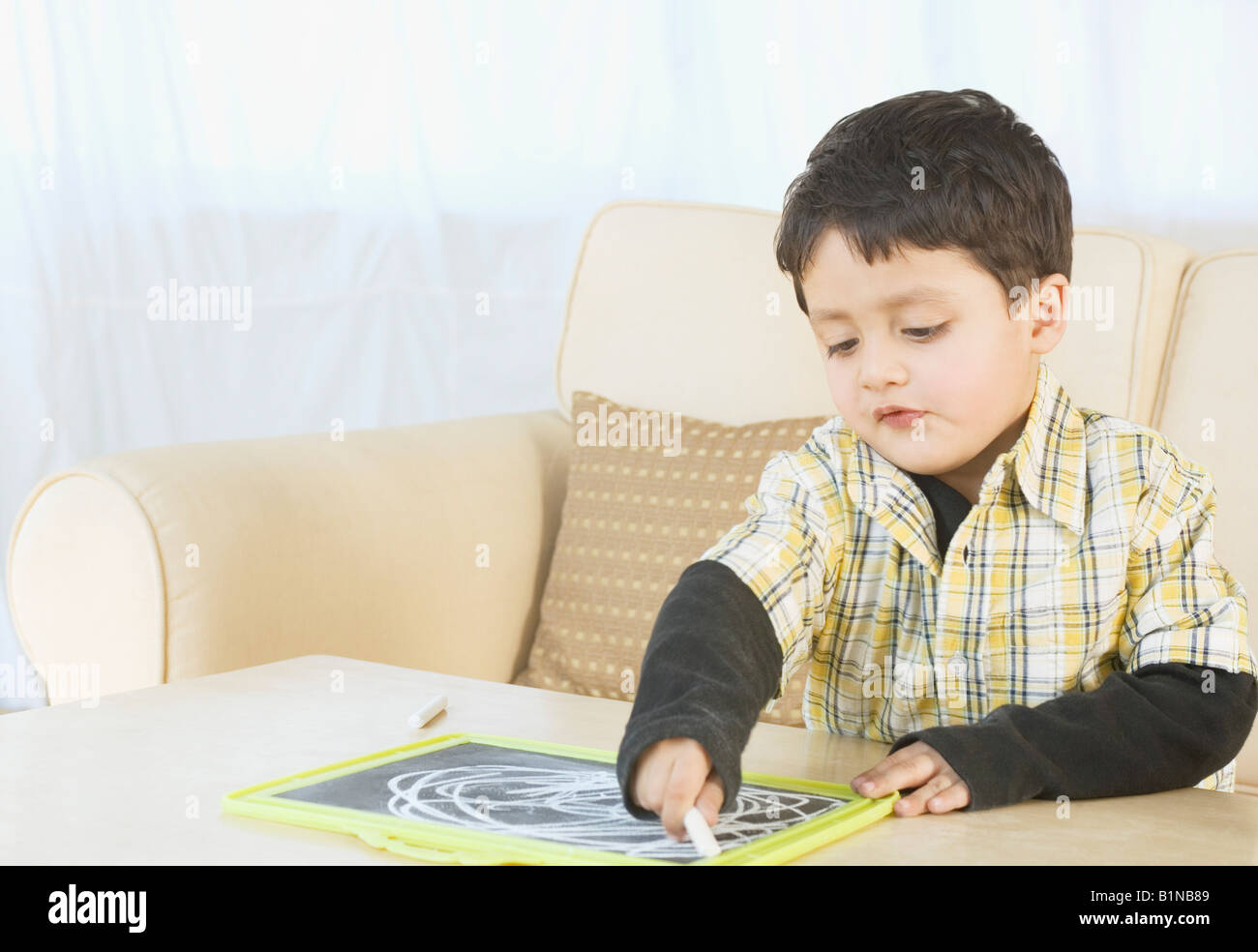 Boy writing on a slate Stock Photo - Alamy