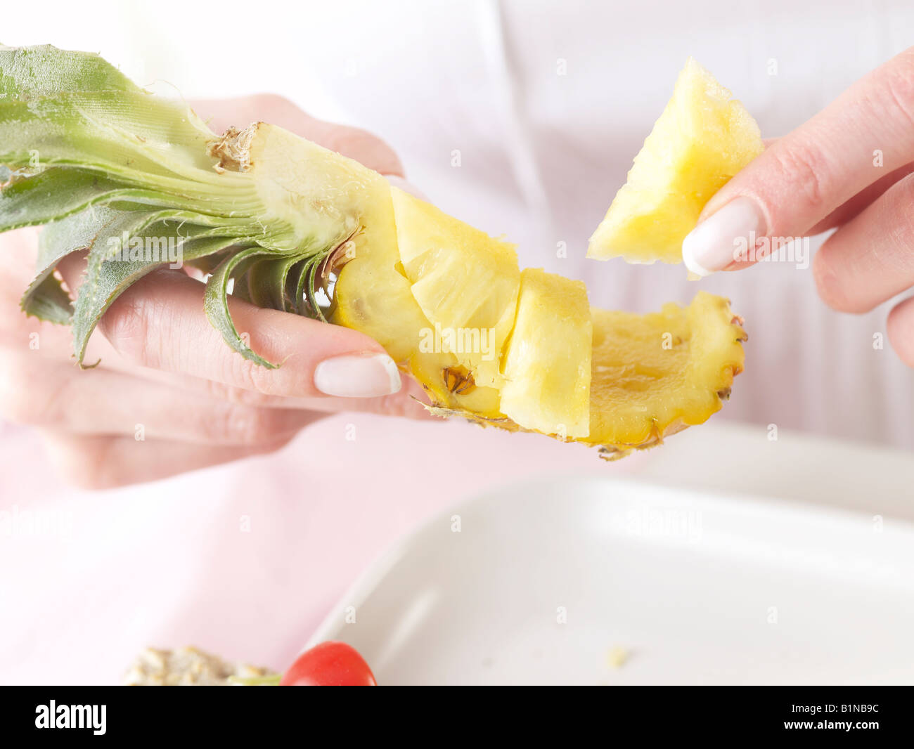 Woman is eating pineapple Stock Photo - Alamy