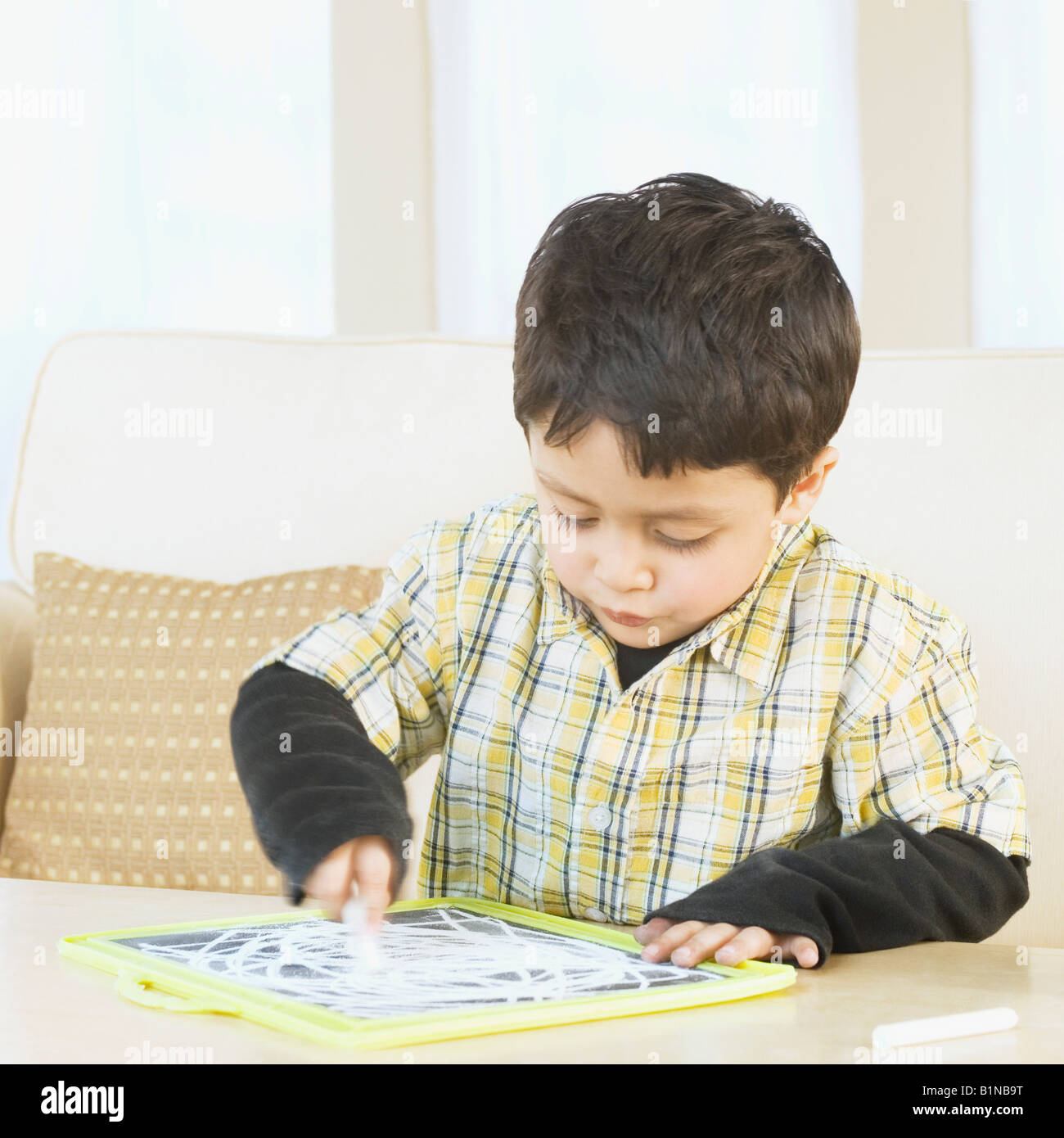 Boy writing on a slate Stock Photo - Alamy