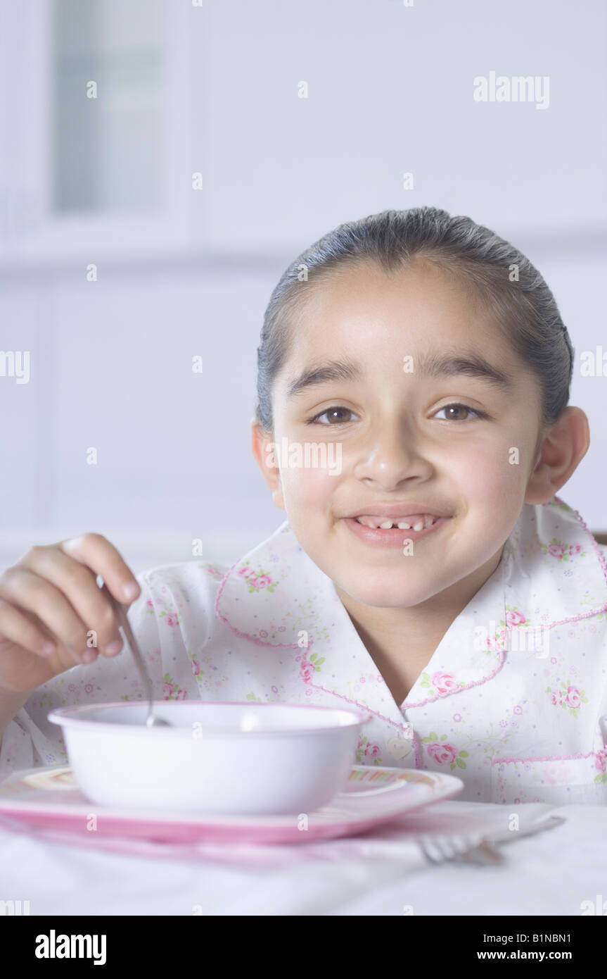 Close-up of a girl smiling at a dining table Stock Photo - Alamy