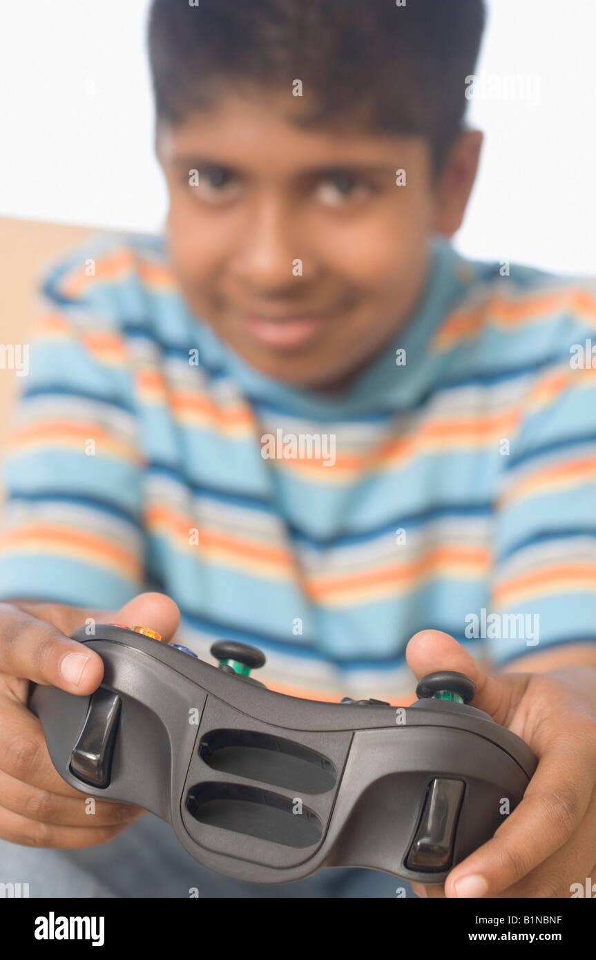 Portrait of a boy playing video game and smiling Stock Photo - Alamy