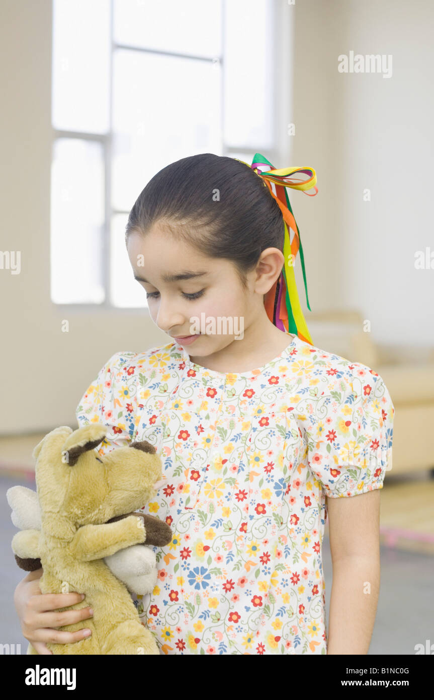 Girl holding a stuffed toy Stock Photo - Alamy