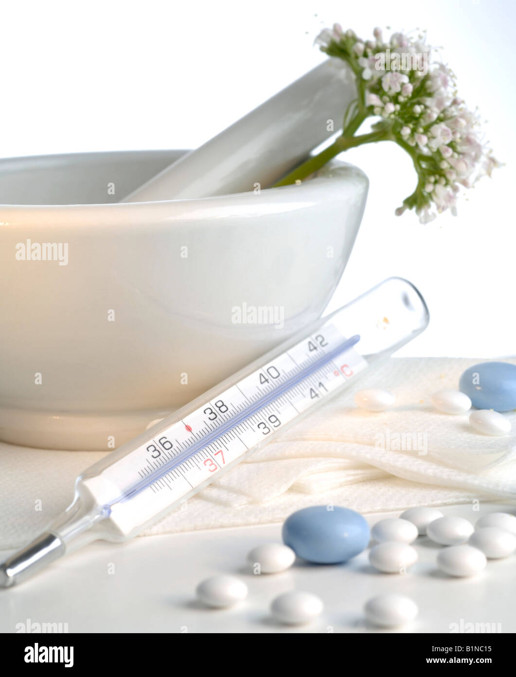 Pills, clinical thermometer and valerian Stock Photo - Alamy