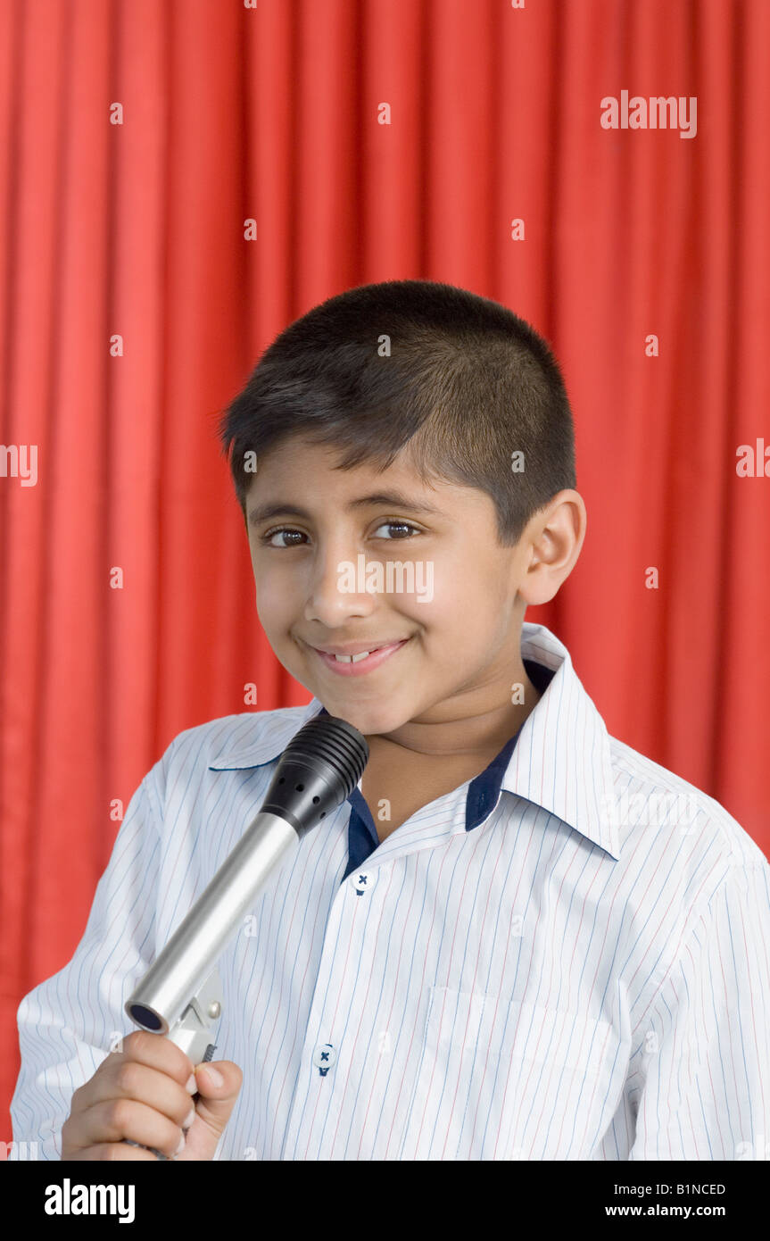 Boy performing on a stage and smiling Stock Photo - Alamy