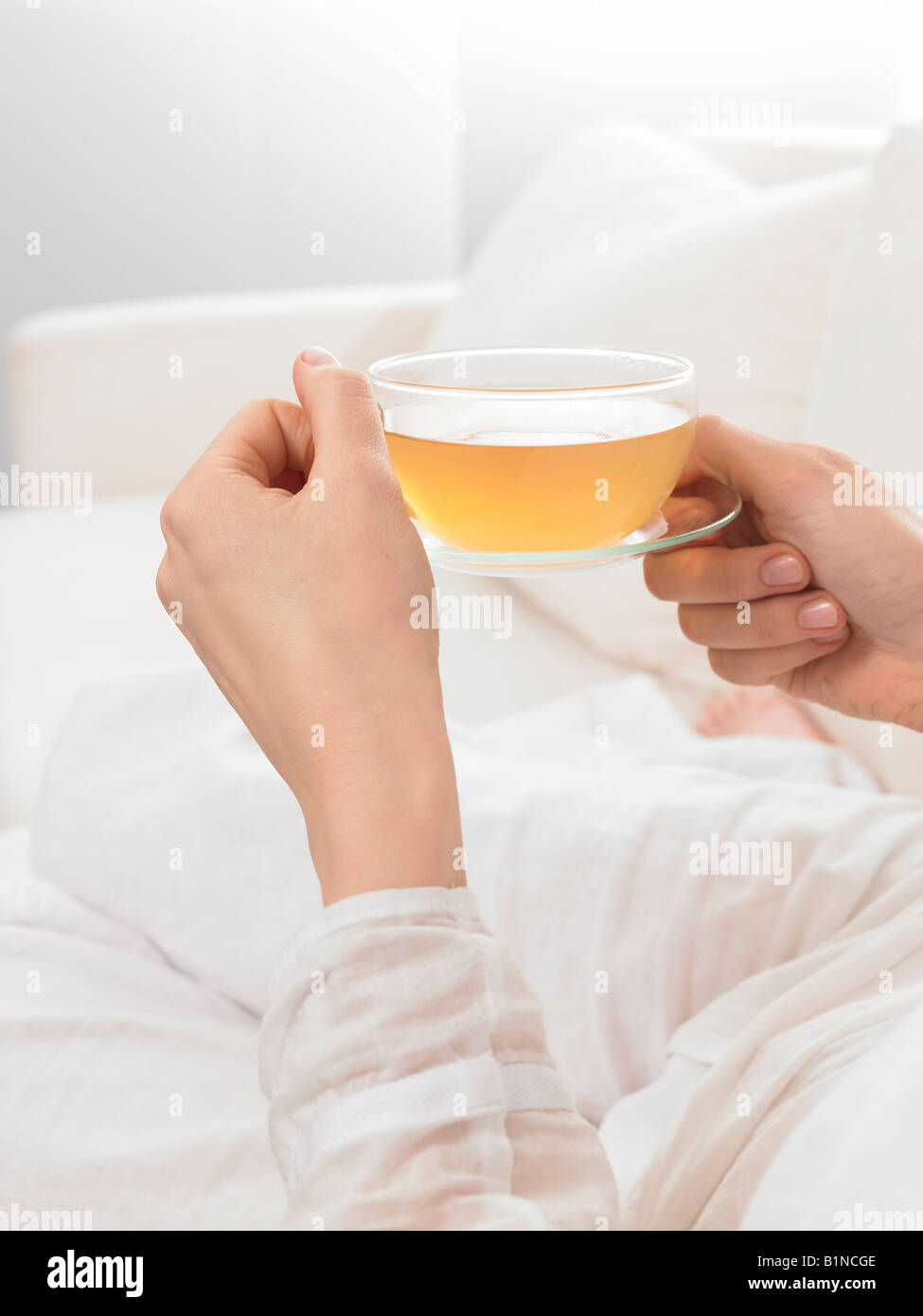 Two hands holding a glass of tea Stock Photo - Alamy