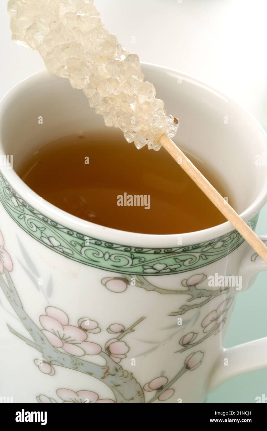Tea mug with a candy stick, close up Stock Photo - Alamy