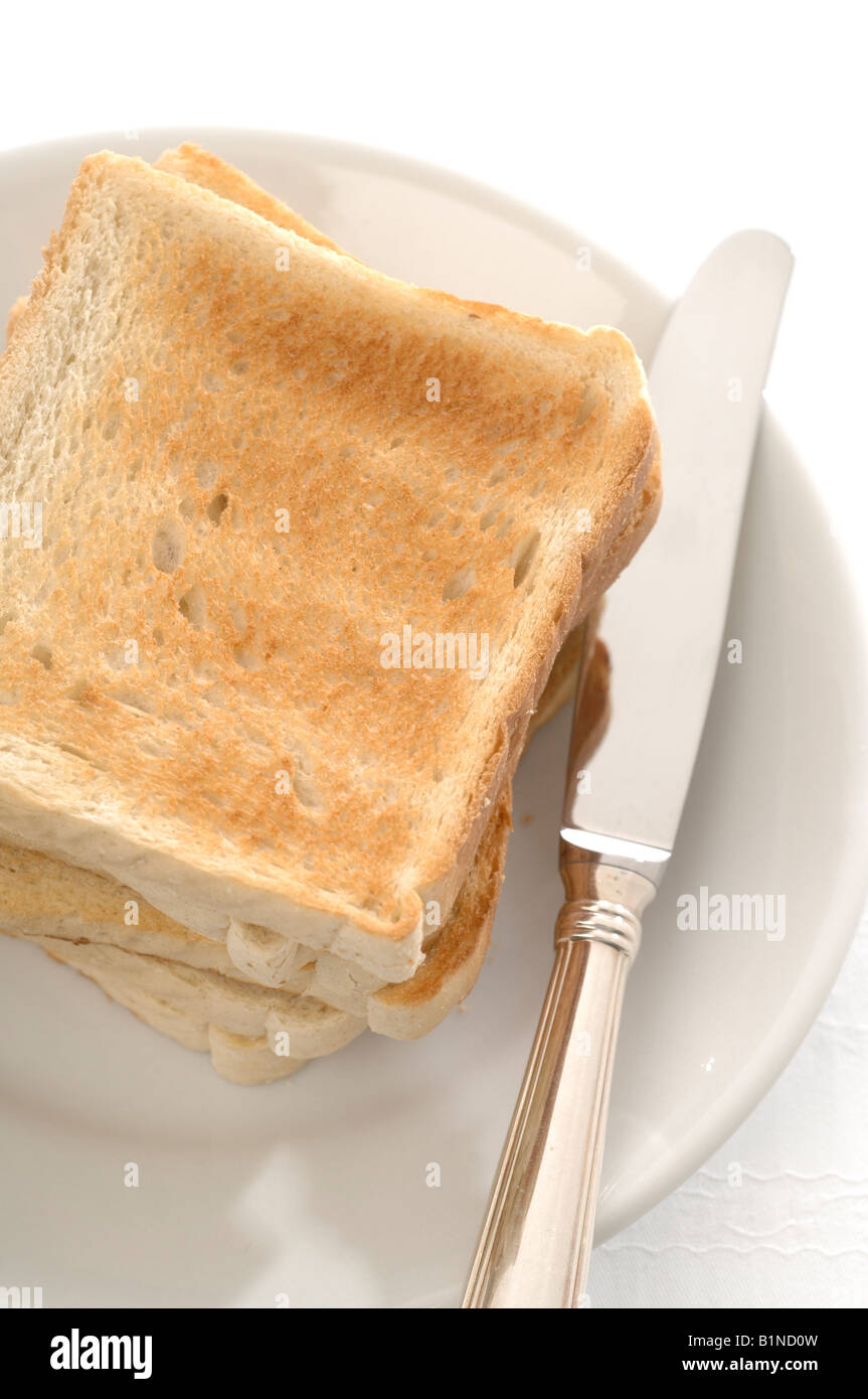Toast on a plate with a knife Stock Photo - Alamy