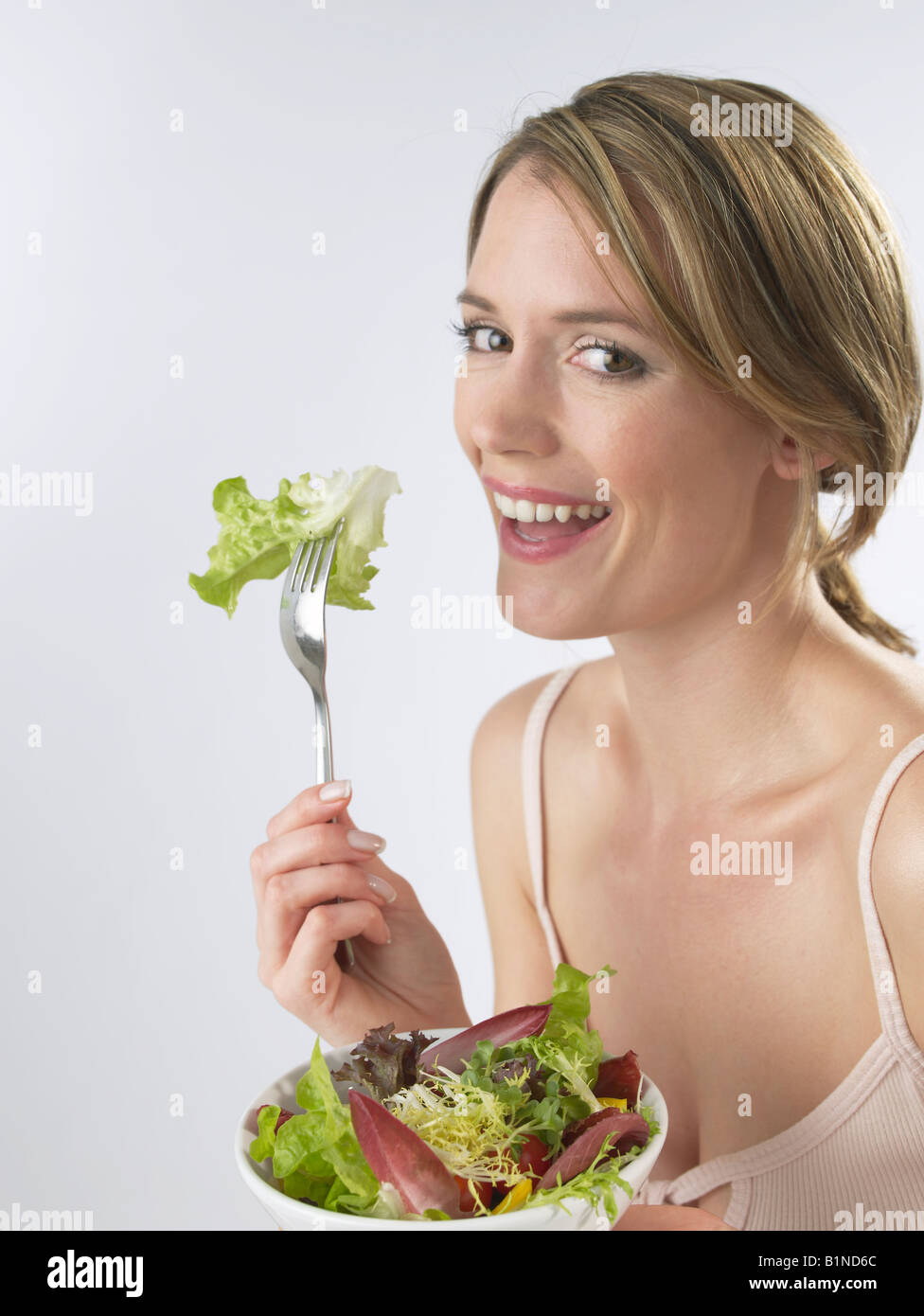 Woman is eating salad Stock Photo - Alamy