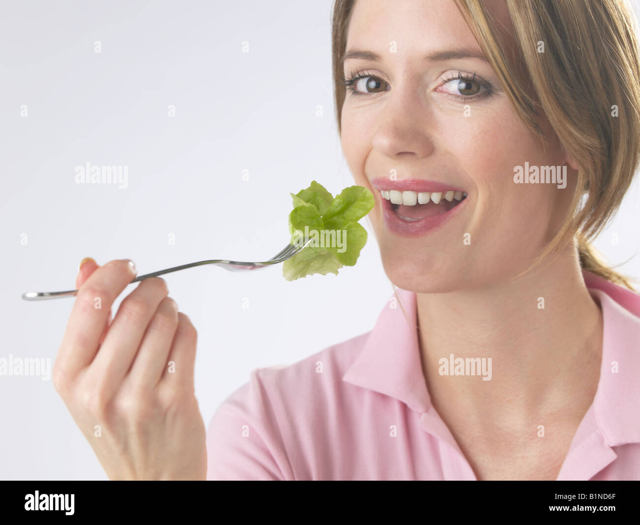 Woman is eating salad Stock Photo - Alamy