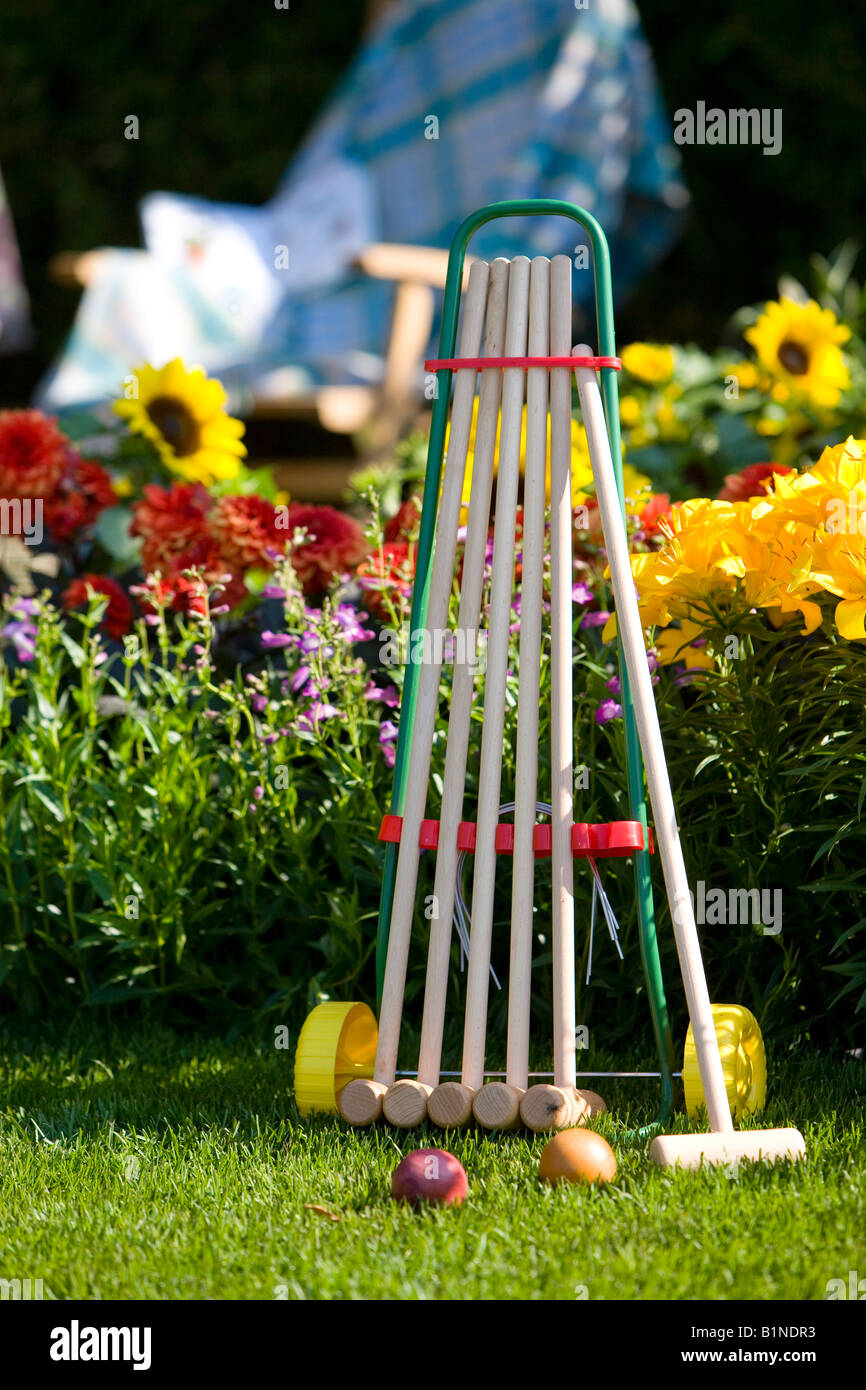 garden croquet set with sunflowers and distant deck chair Stock Photo ...