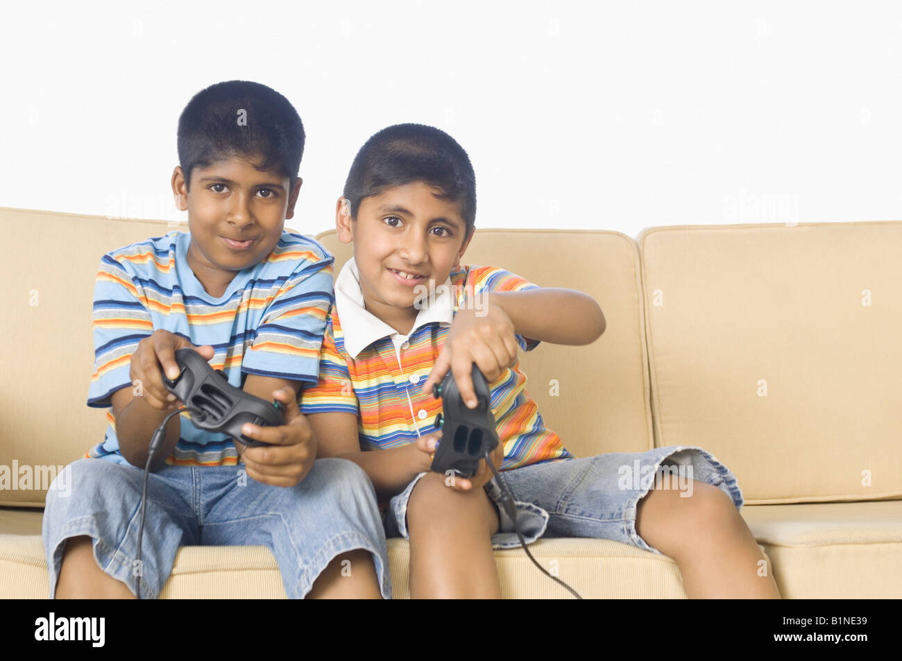 Portrait of two boys playing video game and smiling Stock Photo - Alamy
