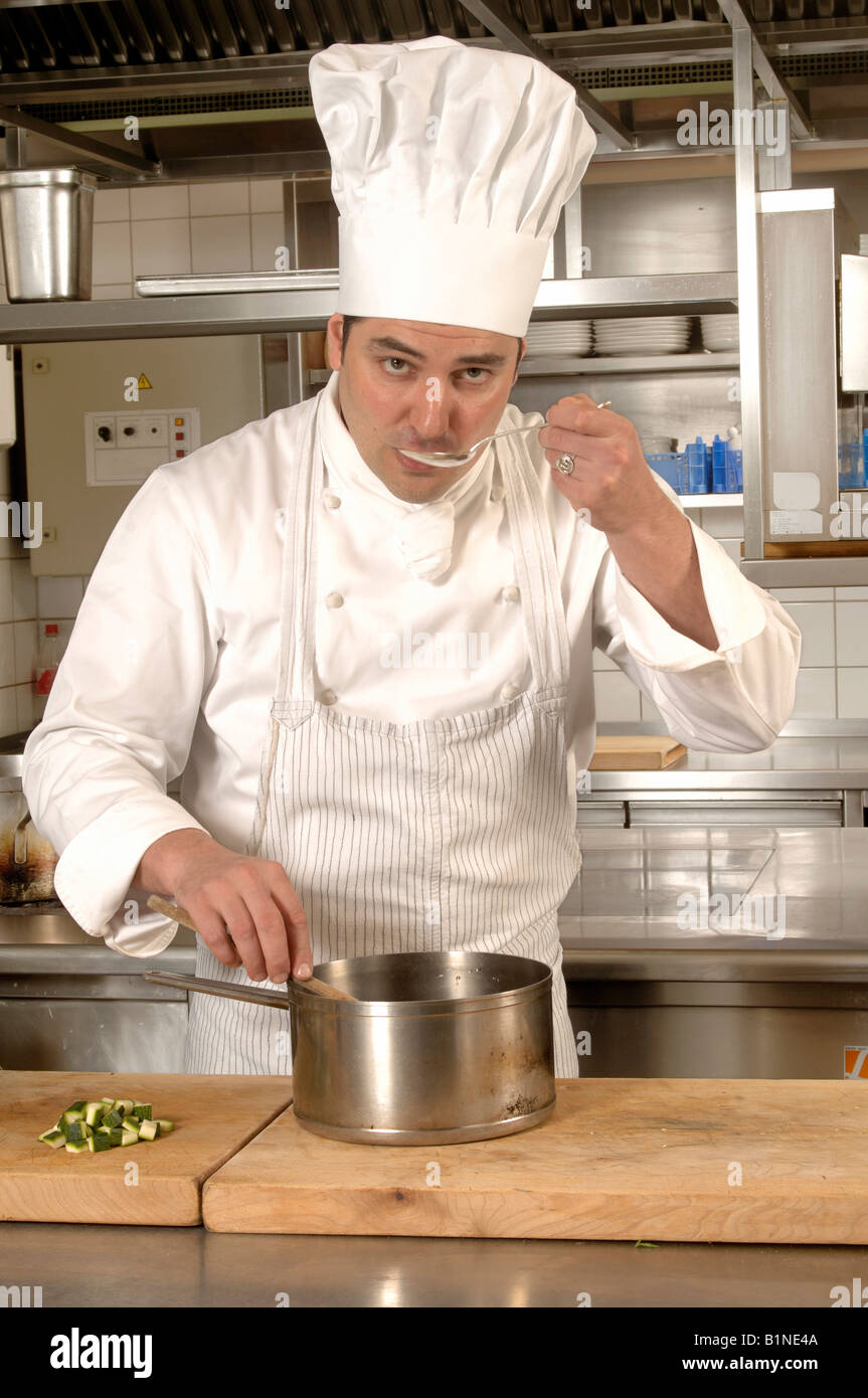 Cook tasting sauce Stock Photo - Alamy