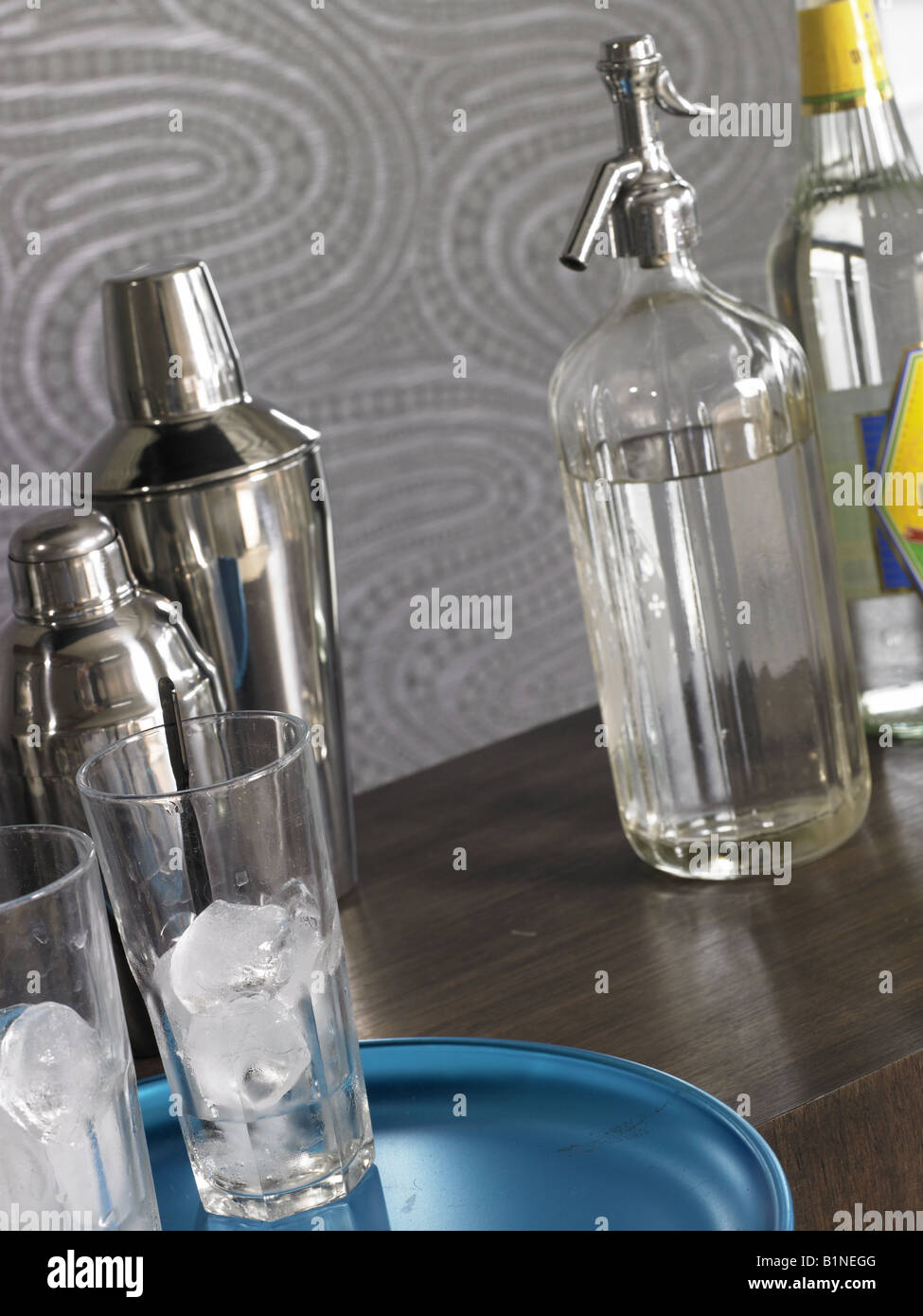 Cocktail bar:Shaker, soda and glasses with ice cubes Stock Photo - Alamy