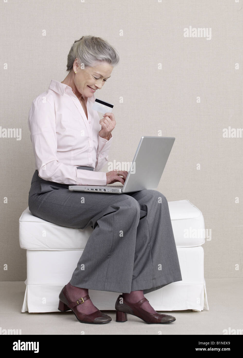 Senior adult with laptop and credit card Stock Photo - Alamy