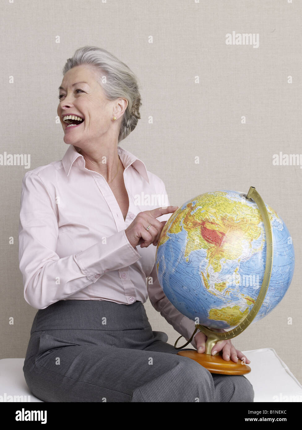 Senior adult with a globe Stock Photo - Alamy
