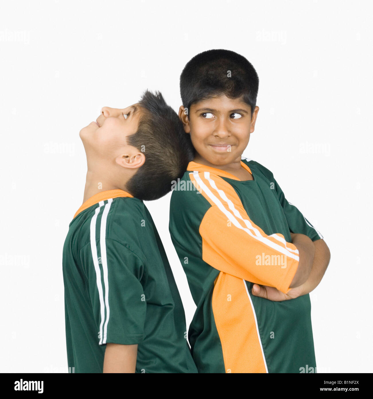 Two boys standing back to back Stock Photo - Alamy