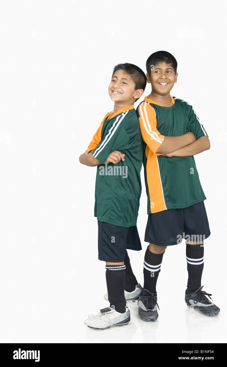 Two boys wearing sports clothing and smiling Stock Photo - Alamy