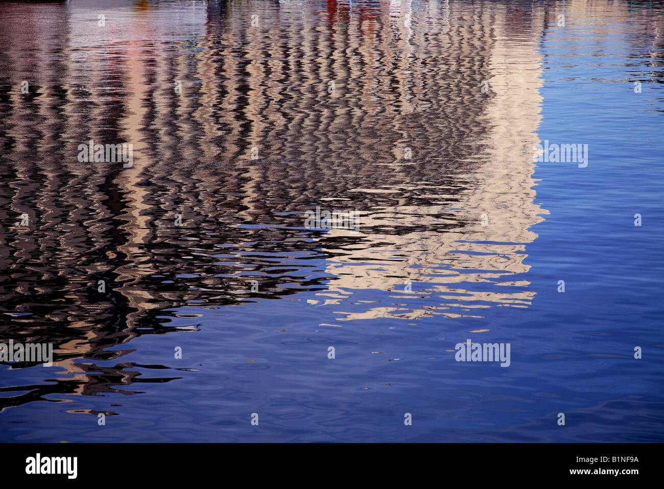 Reflection of building on calm water Stock Photo - Alamy