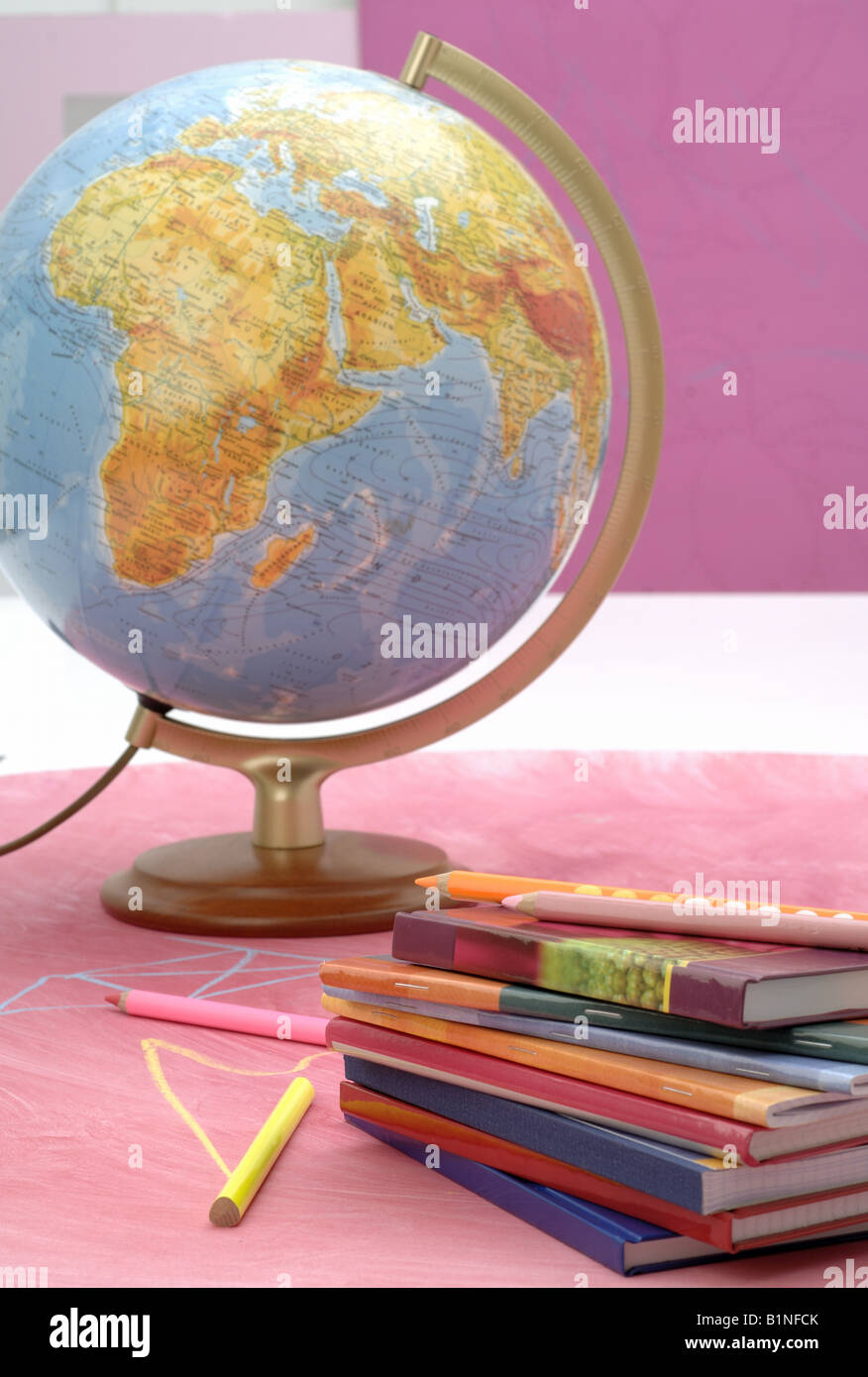 Globe, notebooks and crayons Stock Photo - Alamy