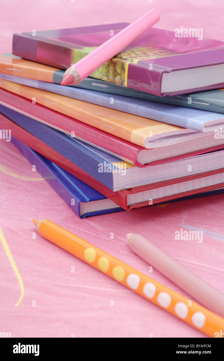 Notebooks and crayons Stock Photo - Alamy