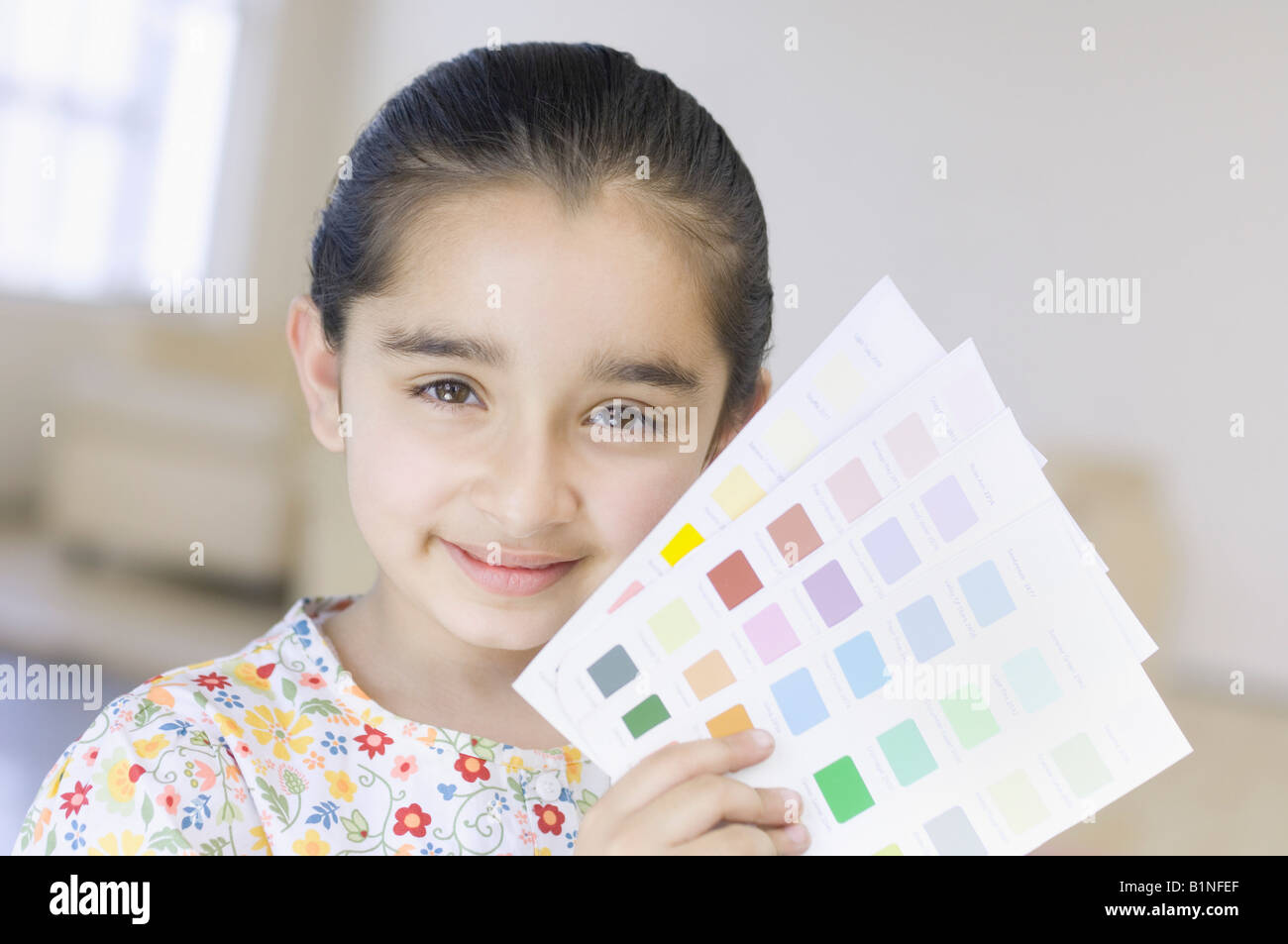Portrait of a girl holding color swatches Stock Photo - Alamy