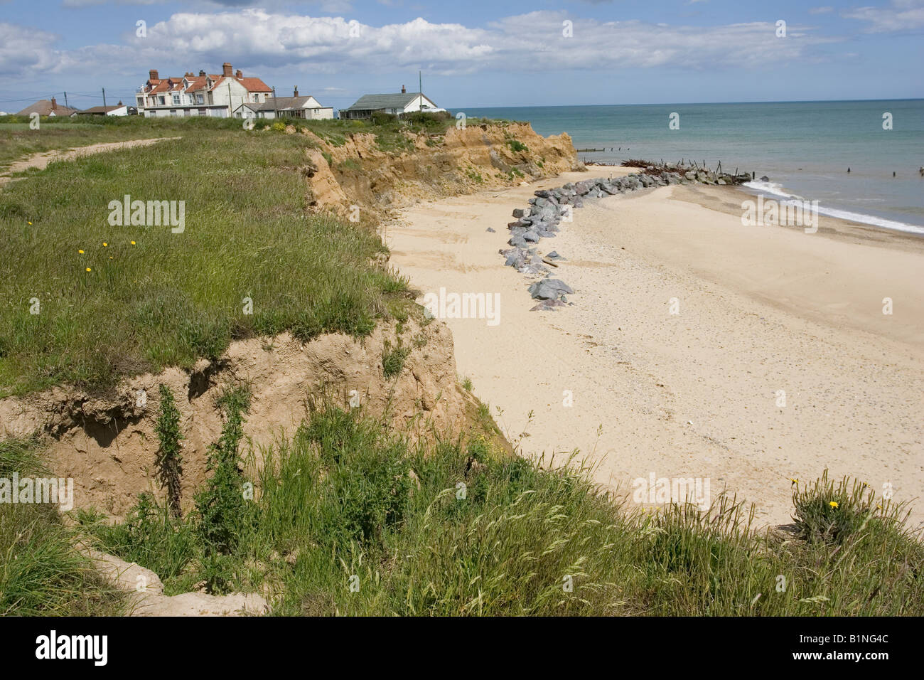 Houses on edge of severely eroded cliffs Happisburgh North Norfolk ...