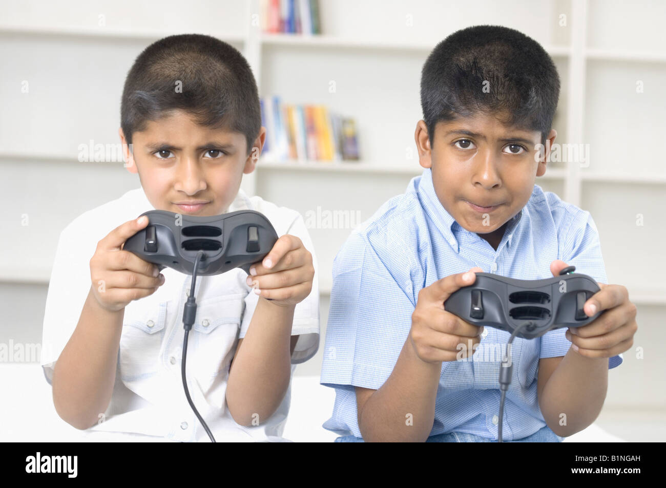 Portrait of two boys playing video game Stock Photo - Alamy