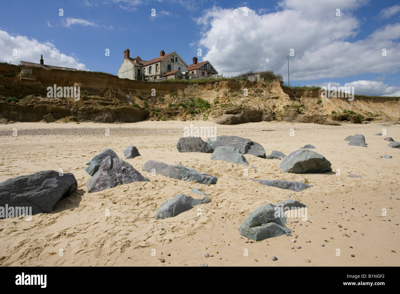 Houses on cliff edge on severely eroded coastline Happisburgh North Norfolk Coast UK Stock Photo ...