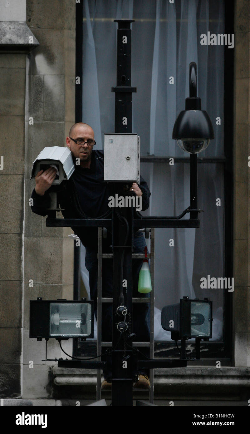 A man cleans CCTV cameras in Central London Photo By Andrew Parsons ...