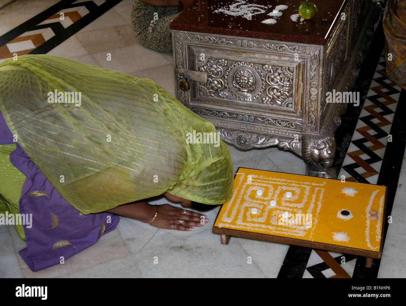 Lady praying in front of a Sathya , Parasvanathaswami Jain Temple ...