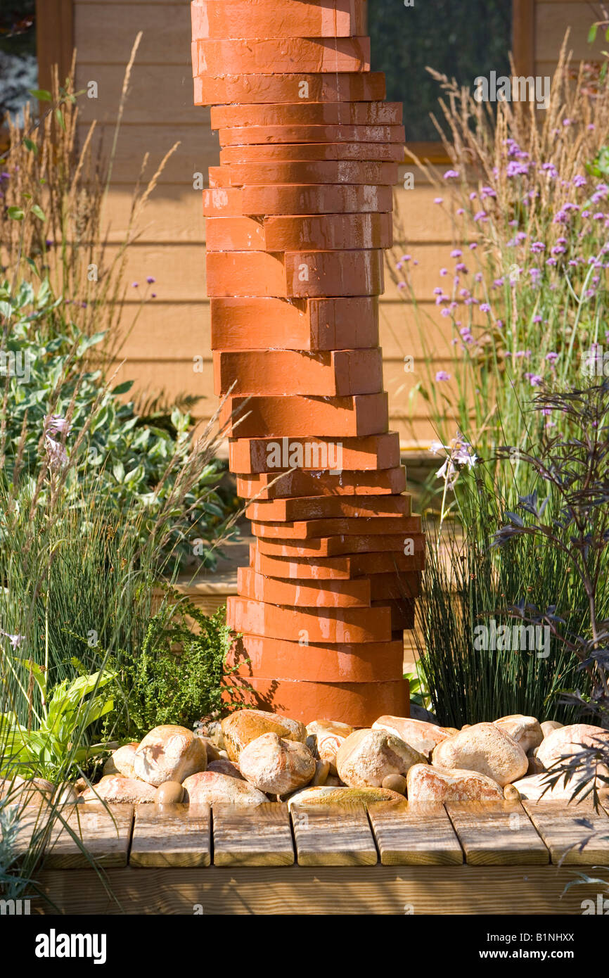 twisted terracotta garden water feature Stock Photo - Alamy