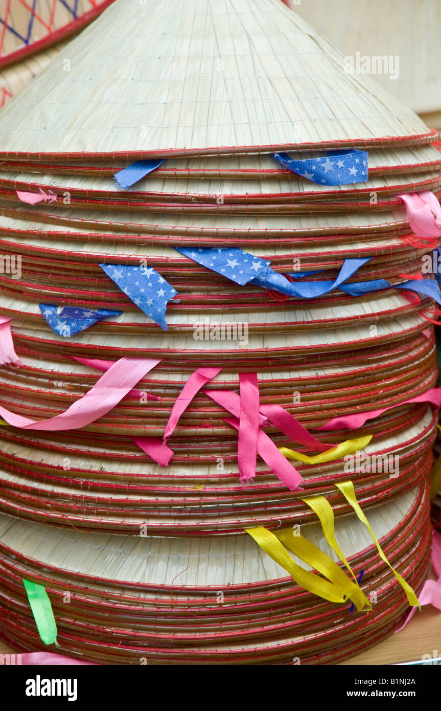 Colourful South East Asian hats piled up ready for sale at a craft ...