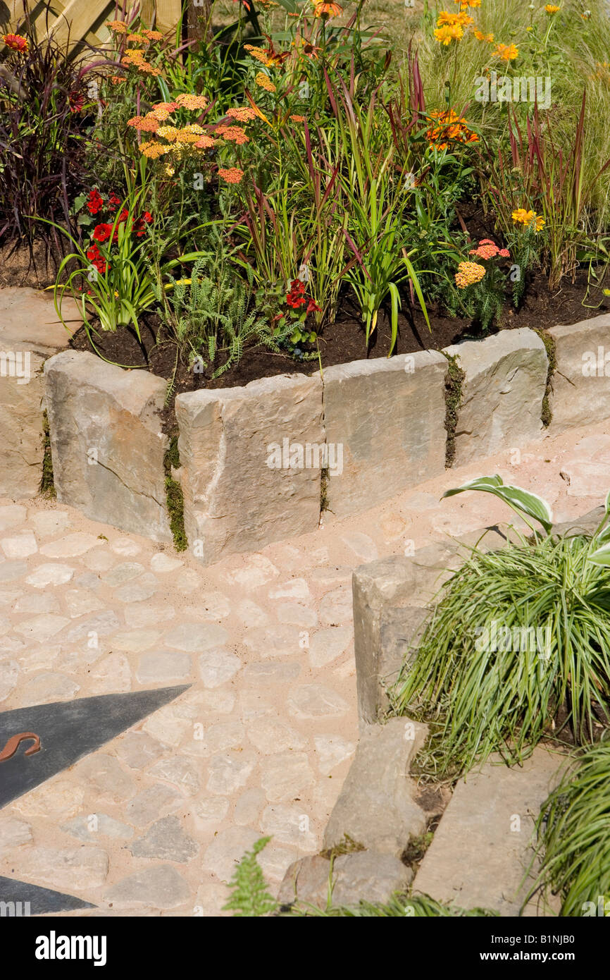 paved path with raised flower beds for easy access Stock Photo - Alamy