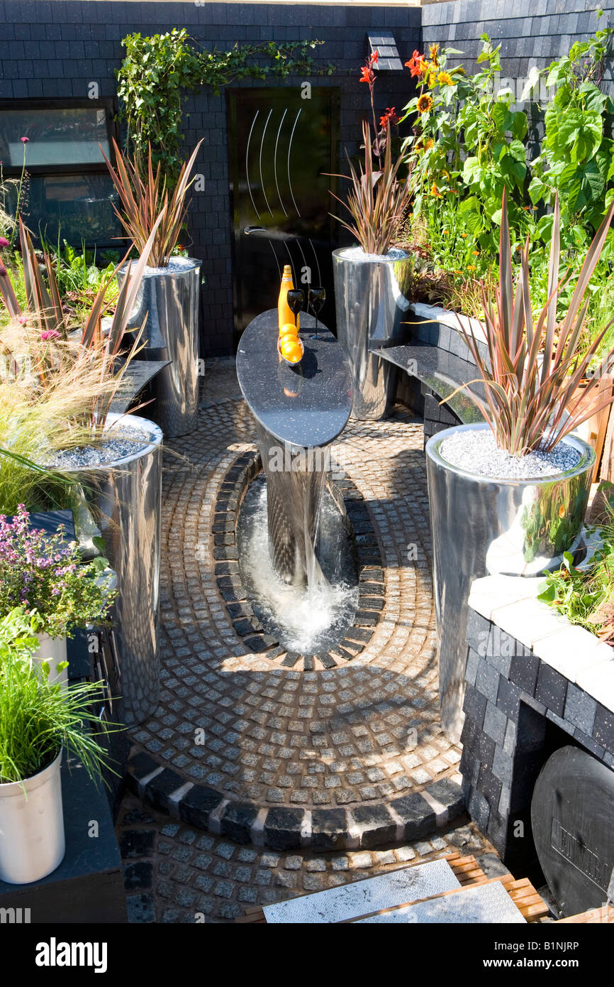 sunken patio with metal and marble planters and table Stock Photo - Alamy