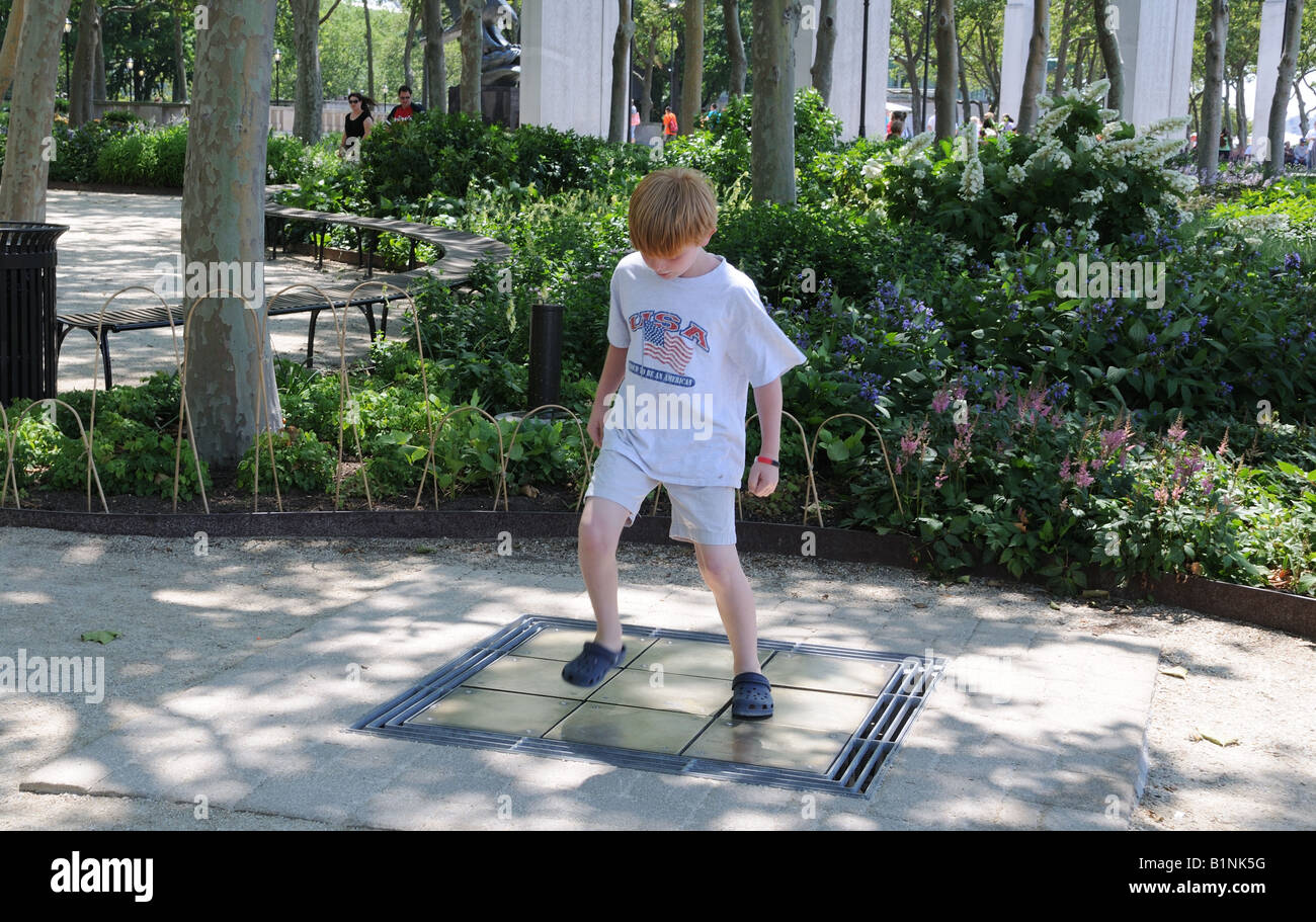 A boy plays the bell board in Battery Park. Each square sounds a ...